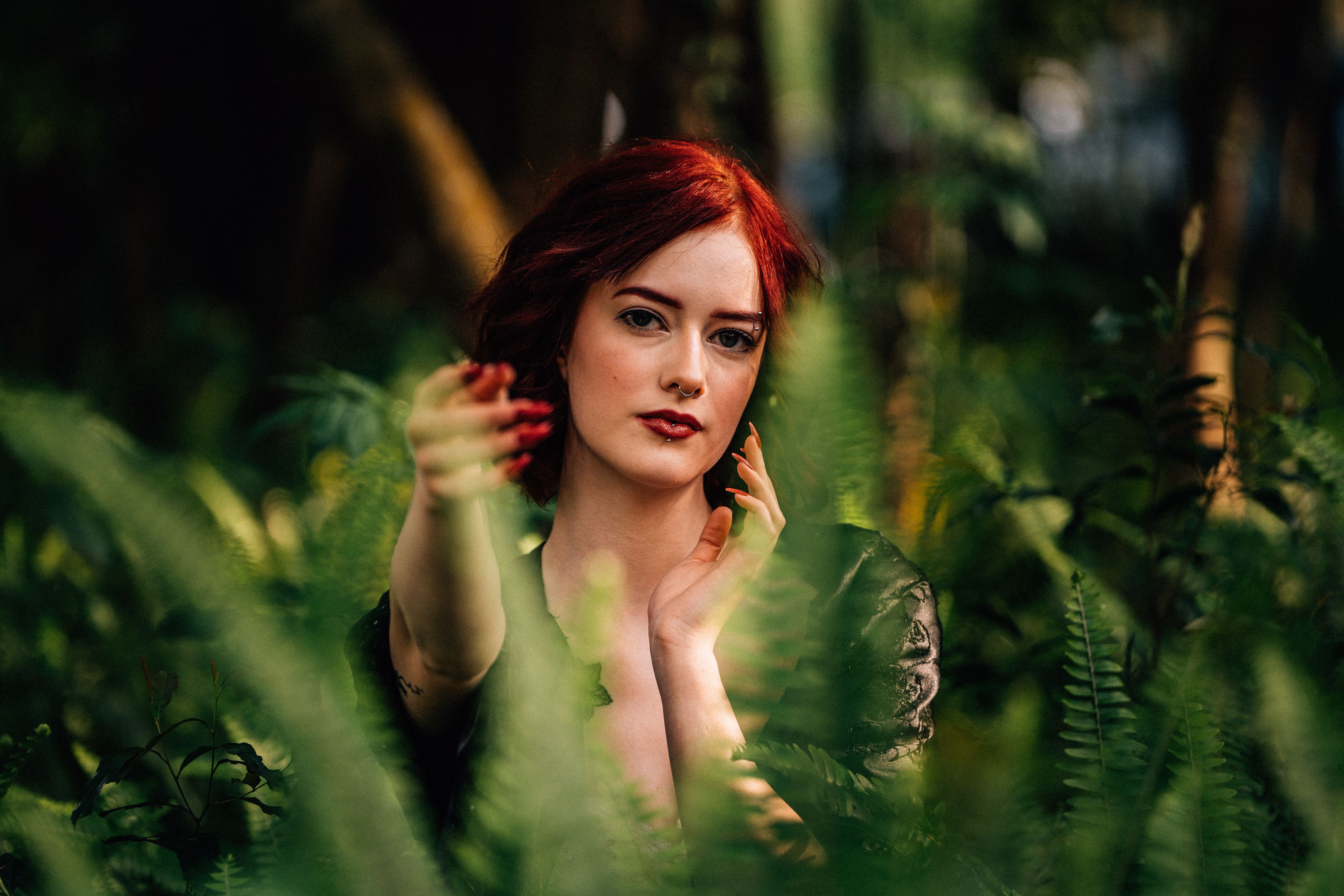 Portrait of Woman Standing among Fern Plants · Free Stock Photo