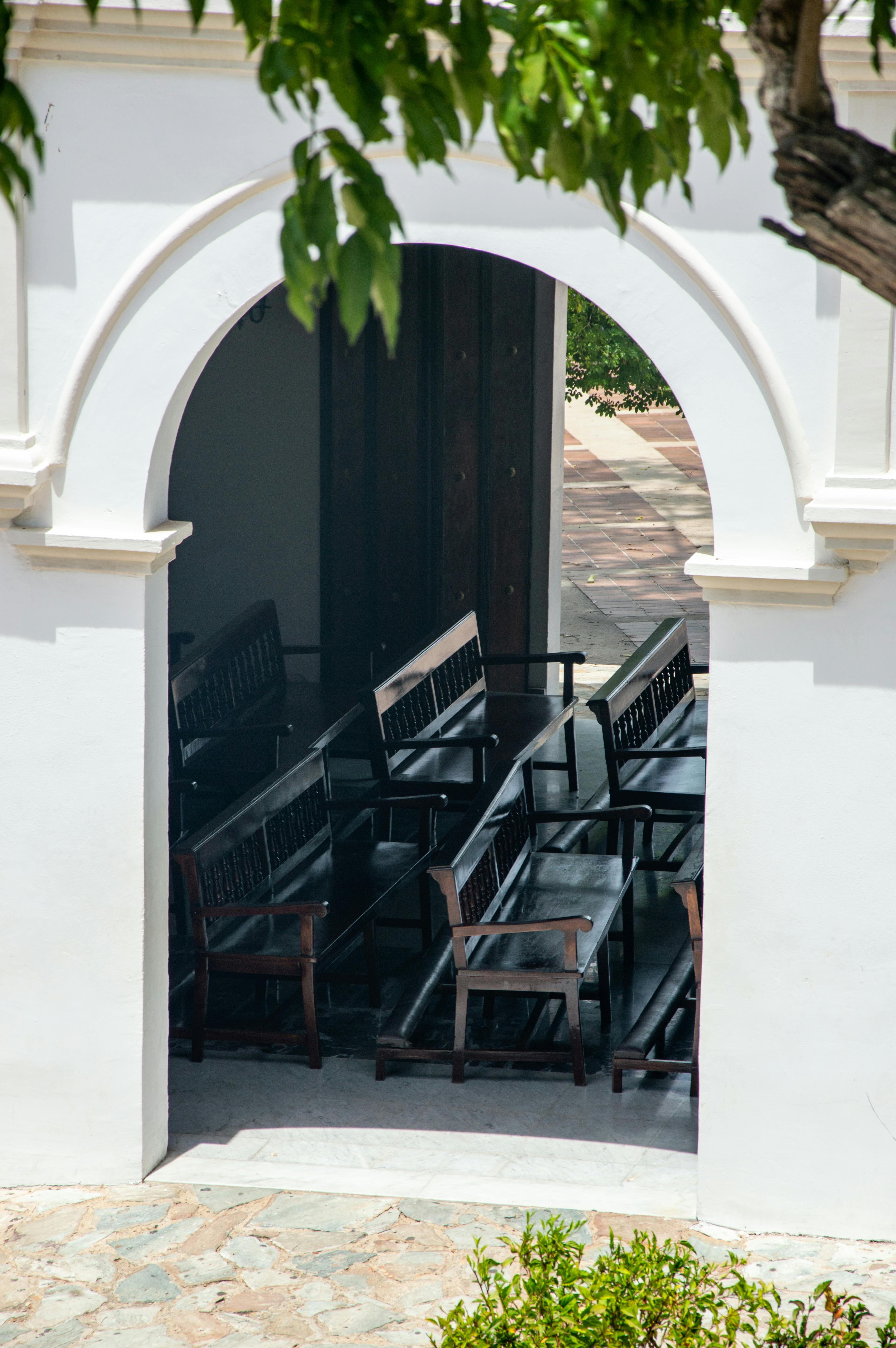 Benches behind Building Arch · Free Stock Photo