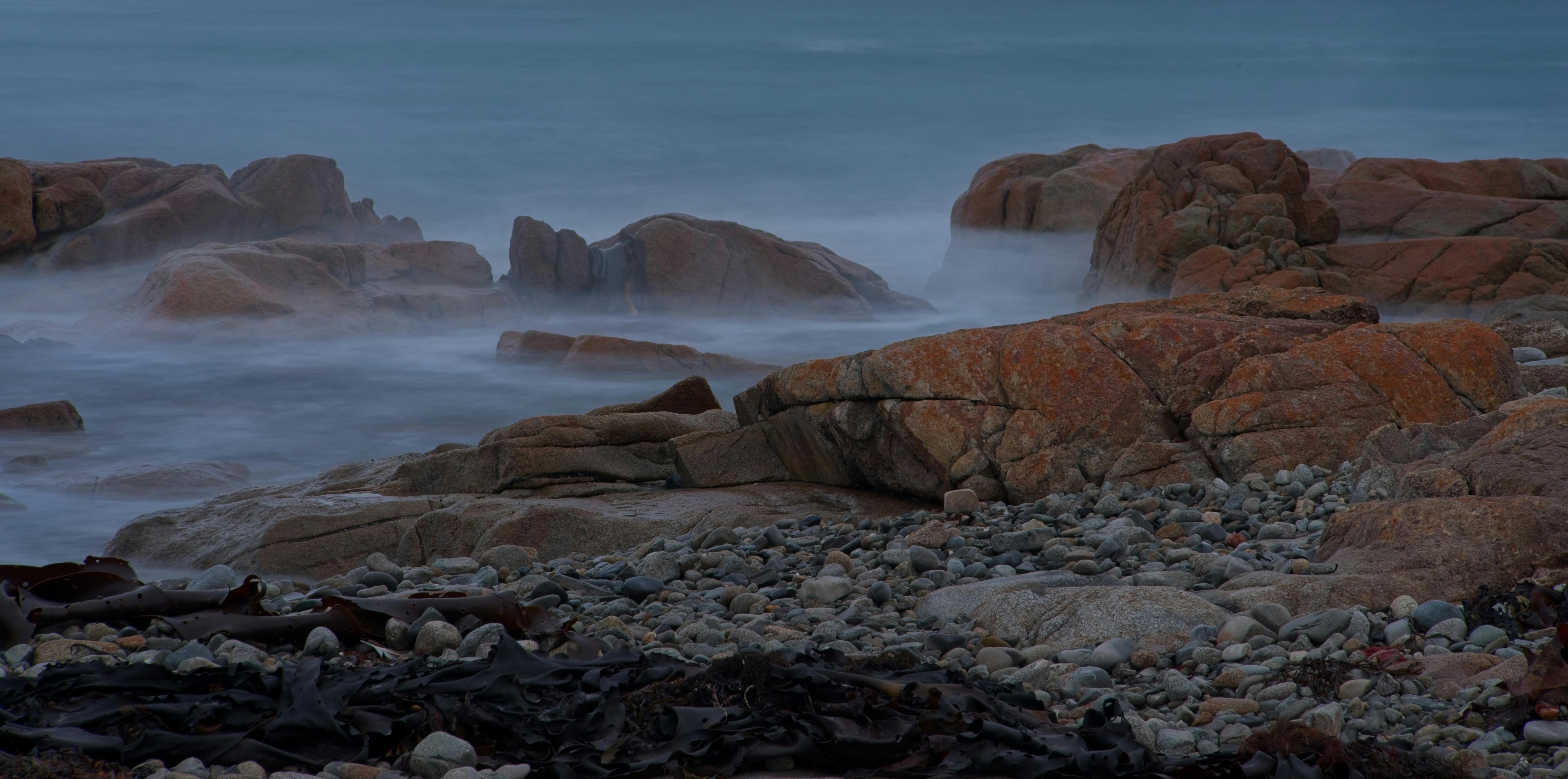 Brown Rock Formation on Body of Water at Daytime · Free Stock Photo