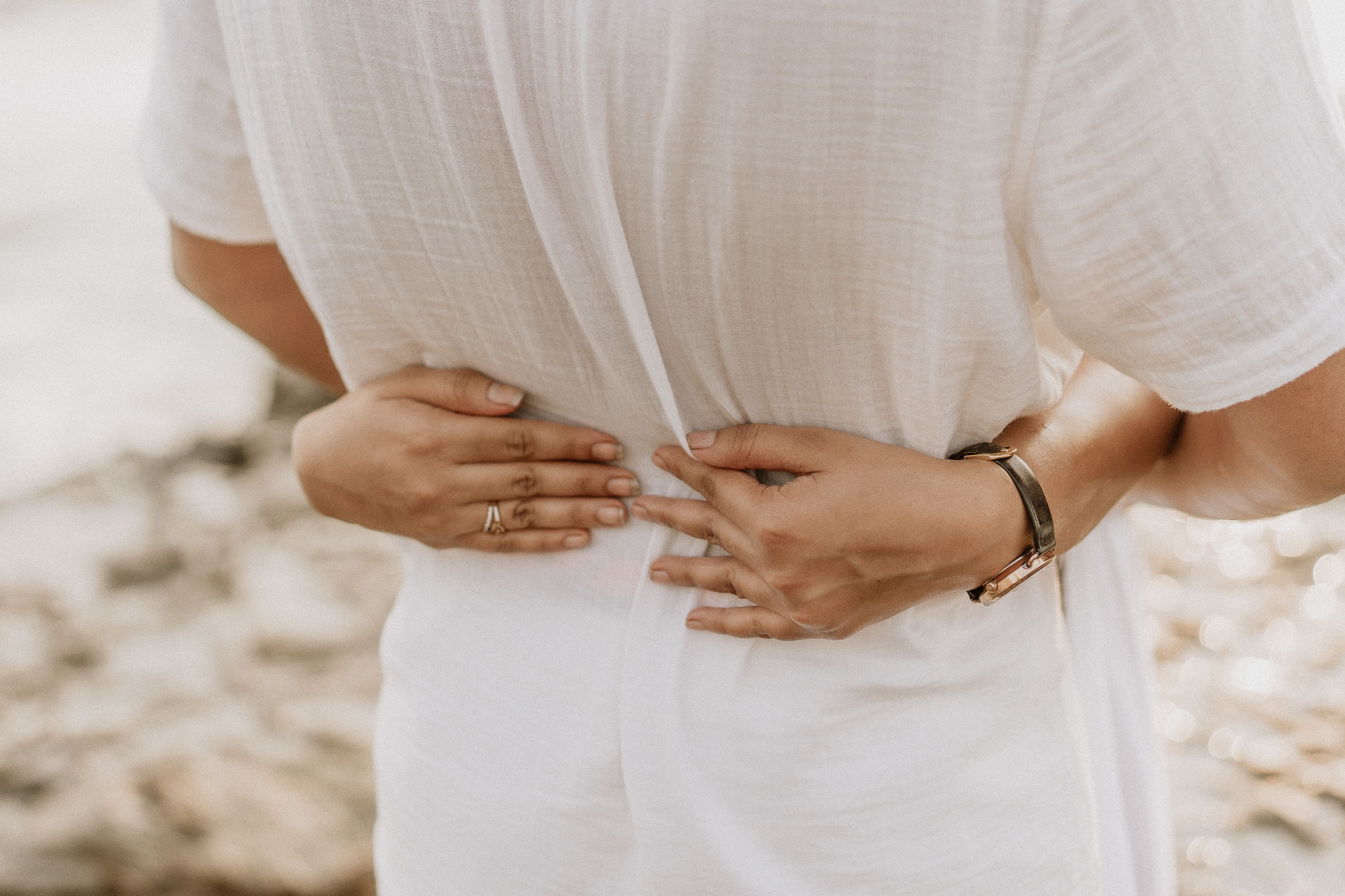 Hands Placed On a Womans Back · Free Stock Photo