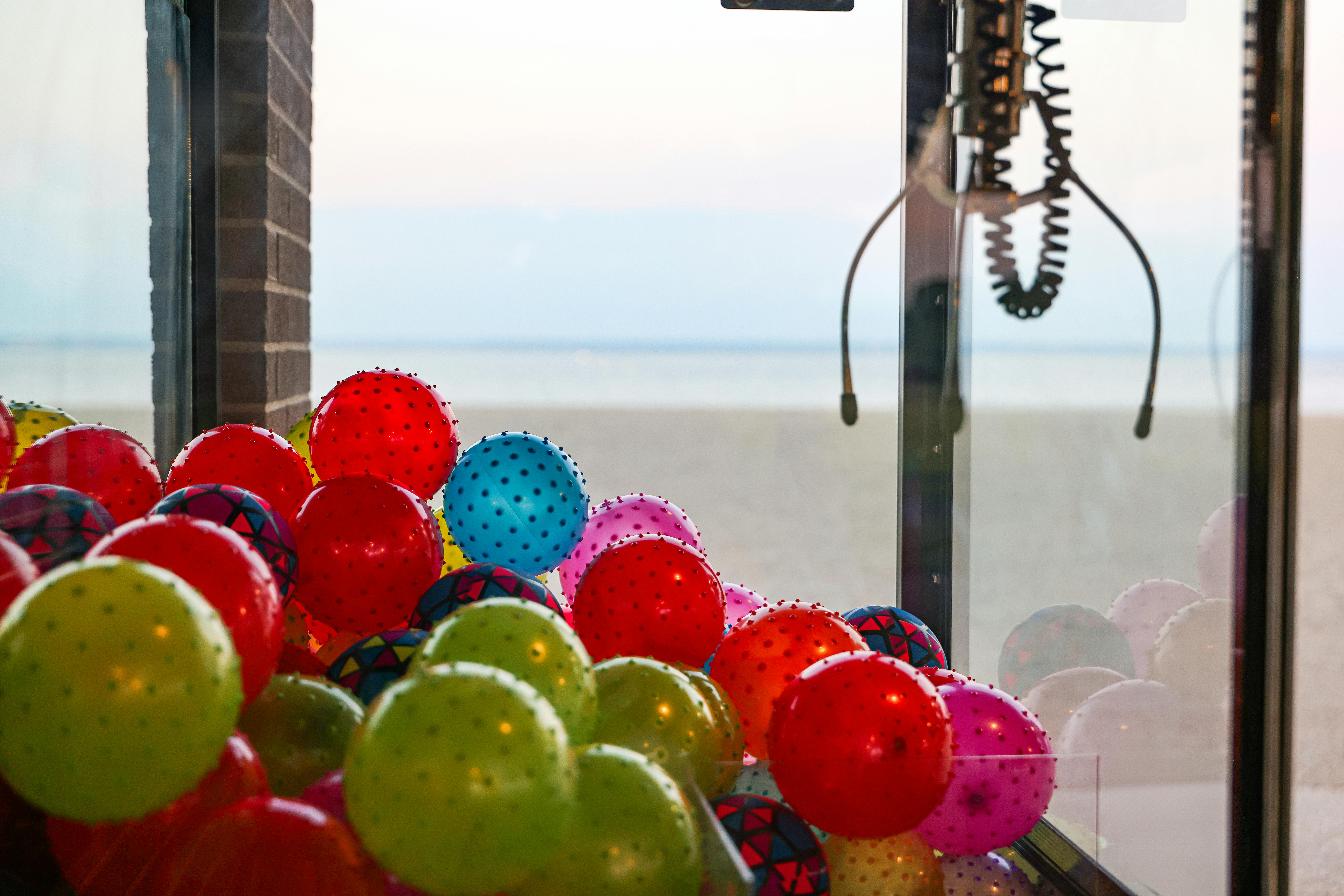 Balls in Claw Machine · Free Stock Photo