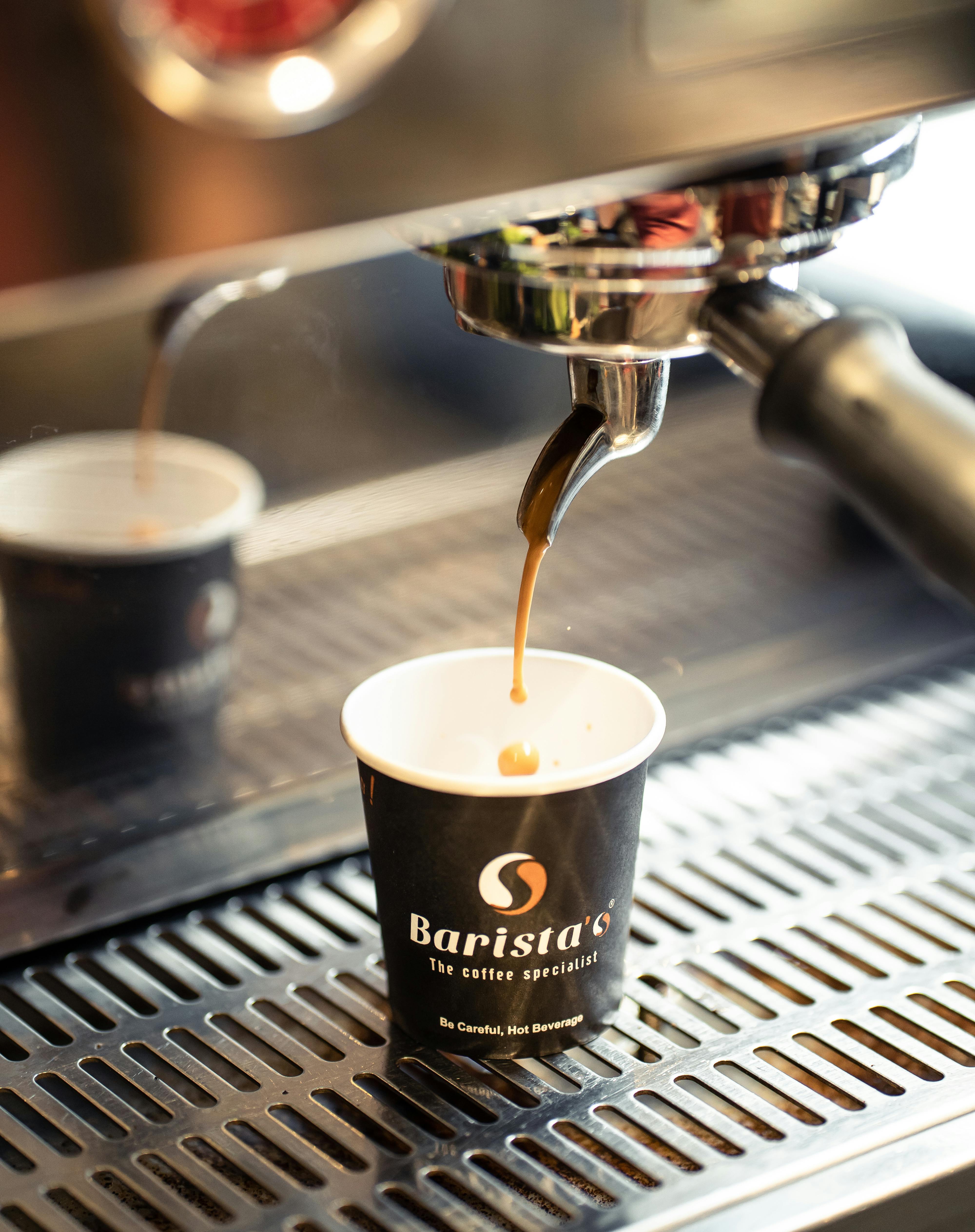 Coffee Dropping into Disposable Cup · Free Stock Photo