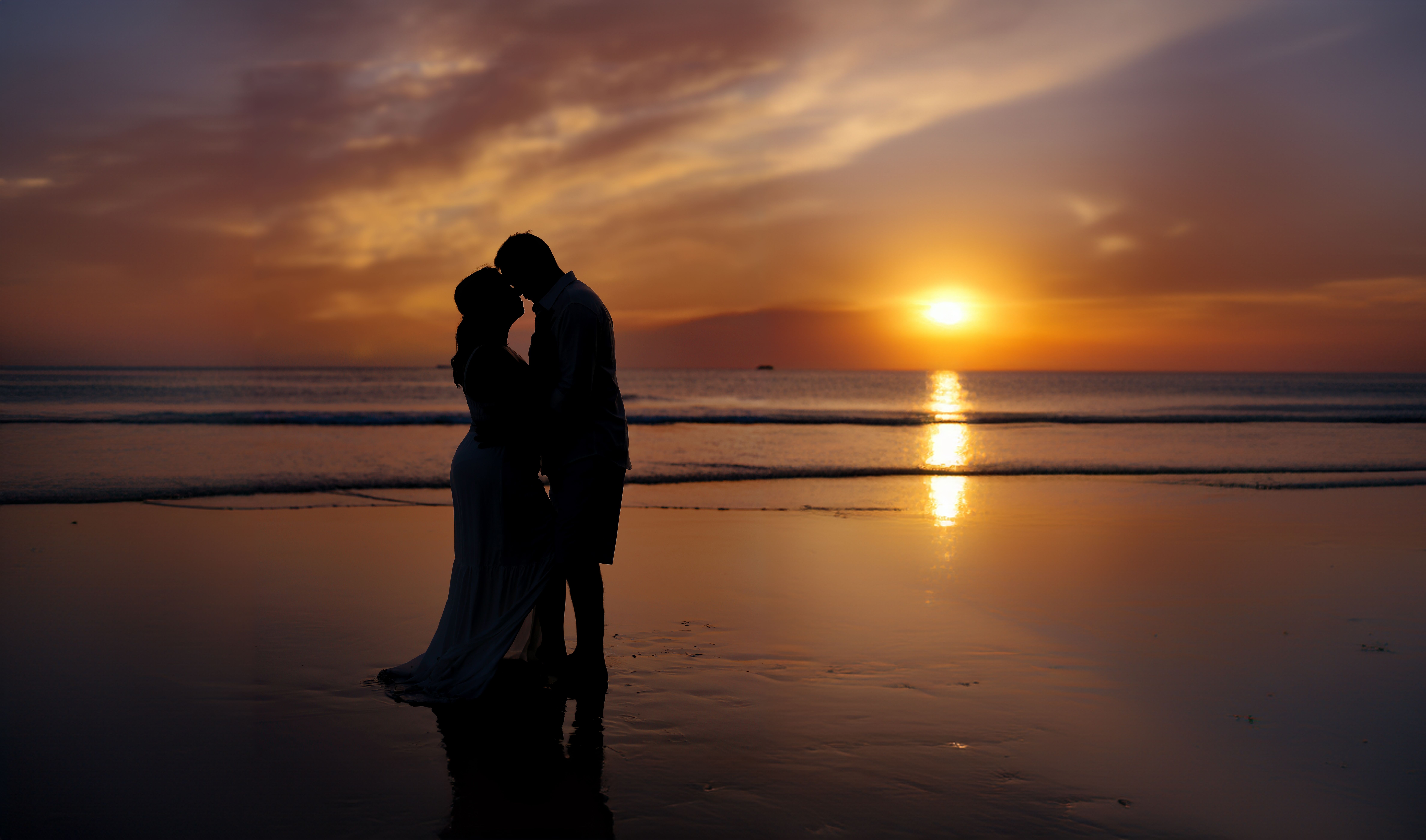 Silhouette of Couple Standing Together on Sea Shore at Sunset · Free ...