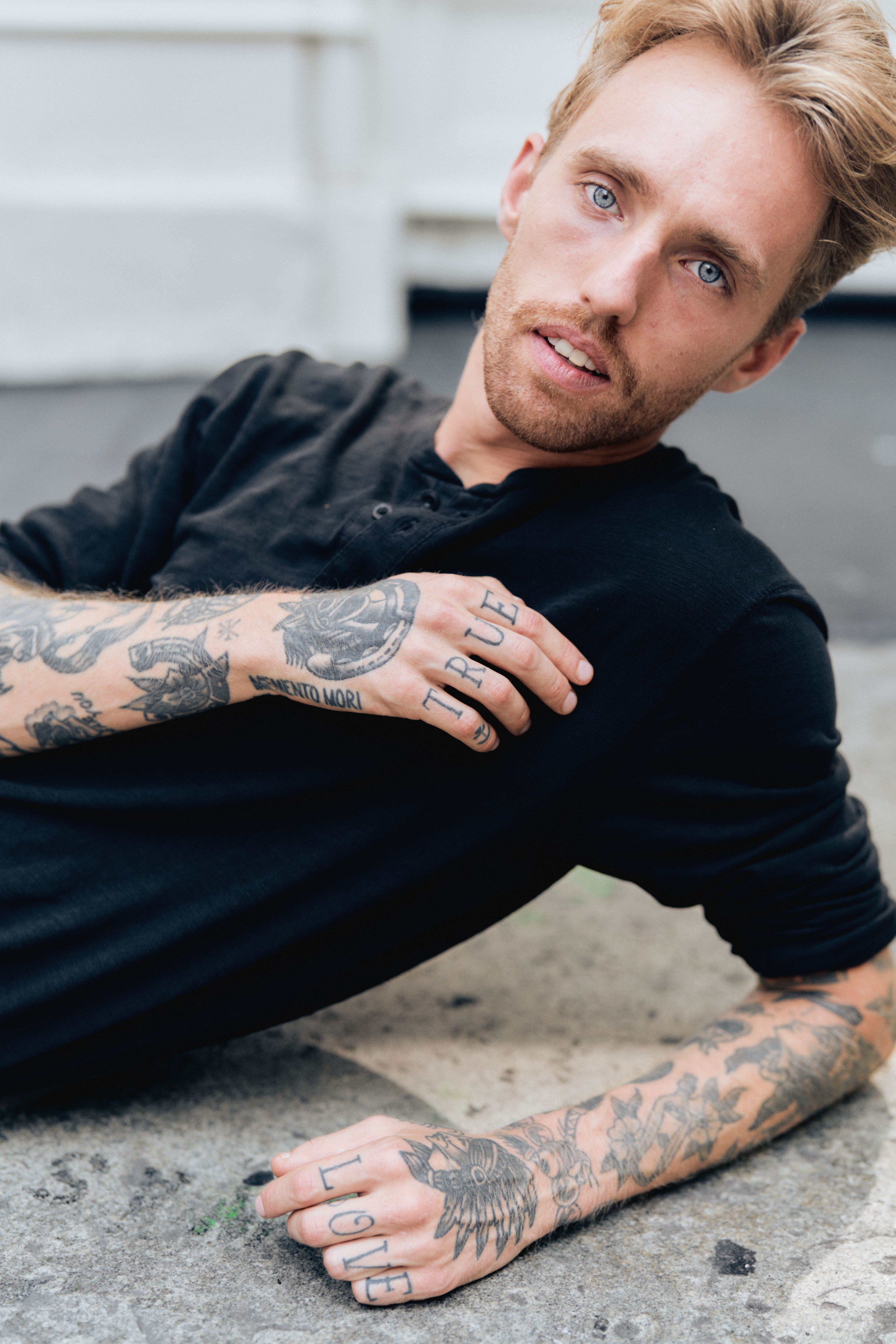 A Man with Tattoos Wearing a Black Shirt · Free Stock Photo