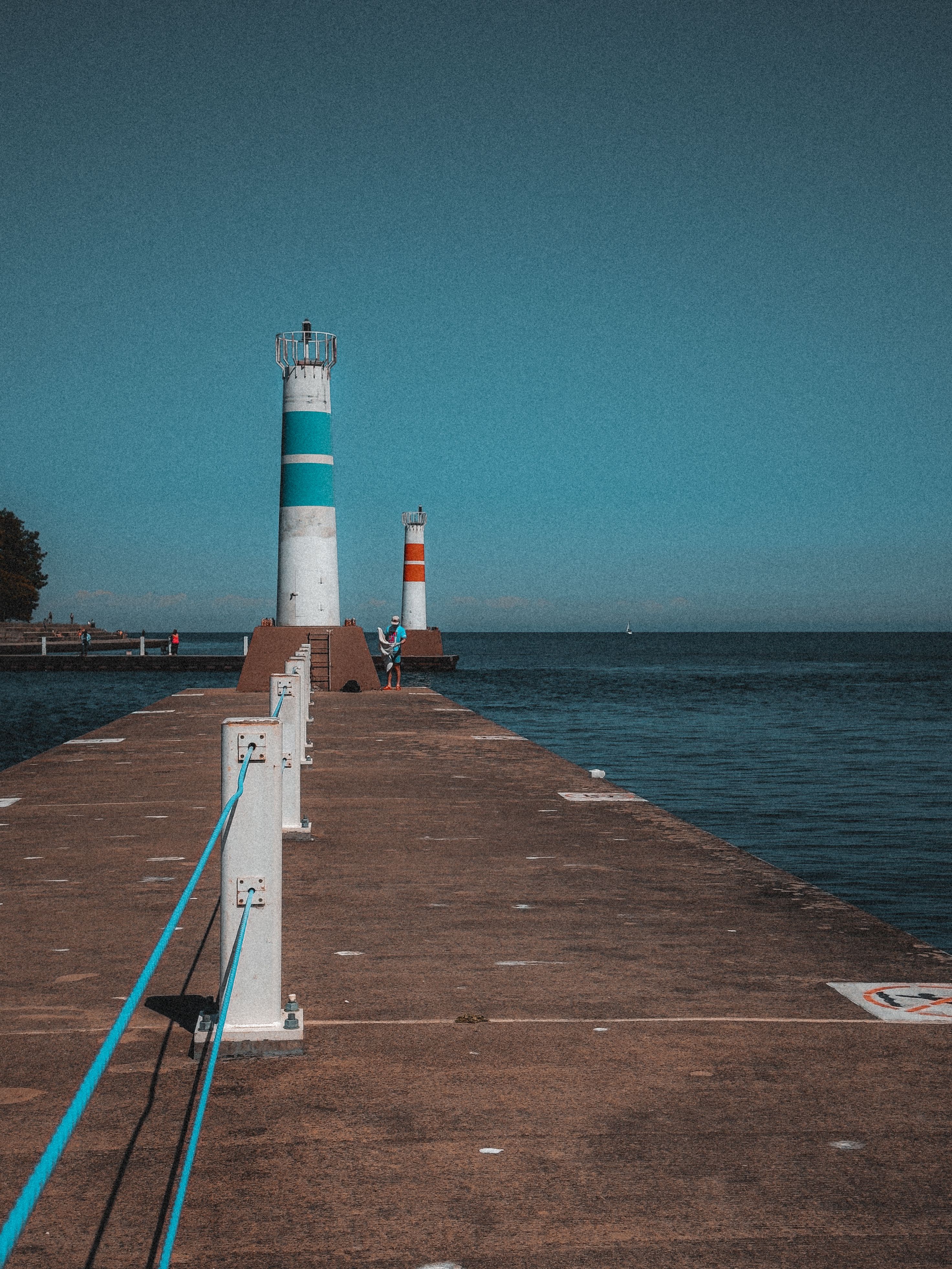 Analog Photo of Pier with Lighthouse in Bay · Free Stock Photo