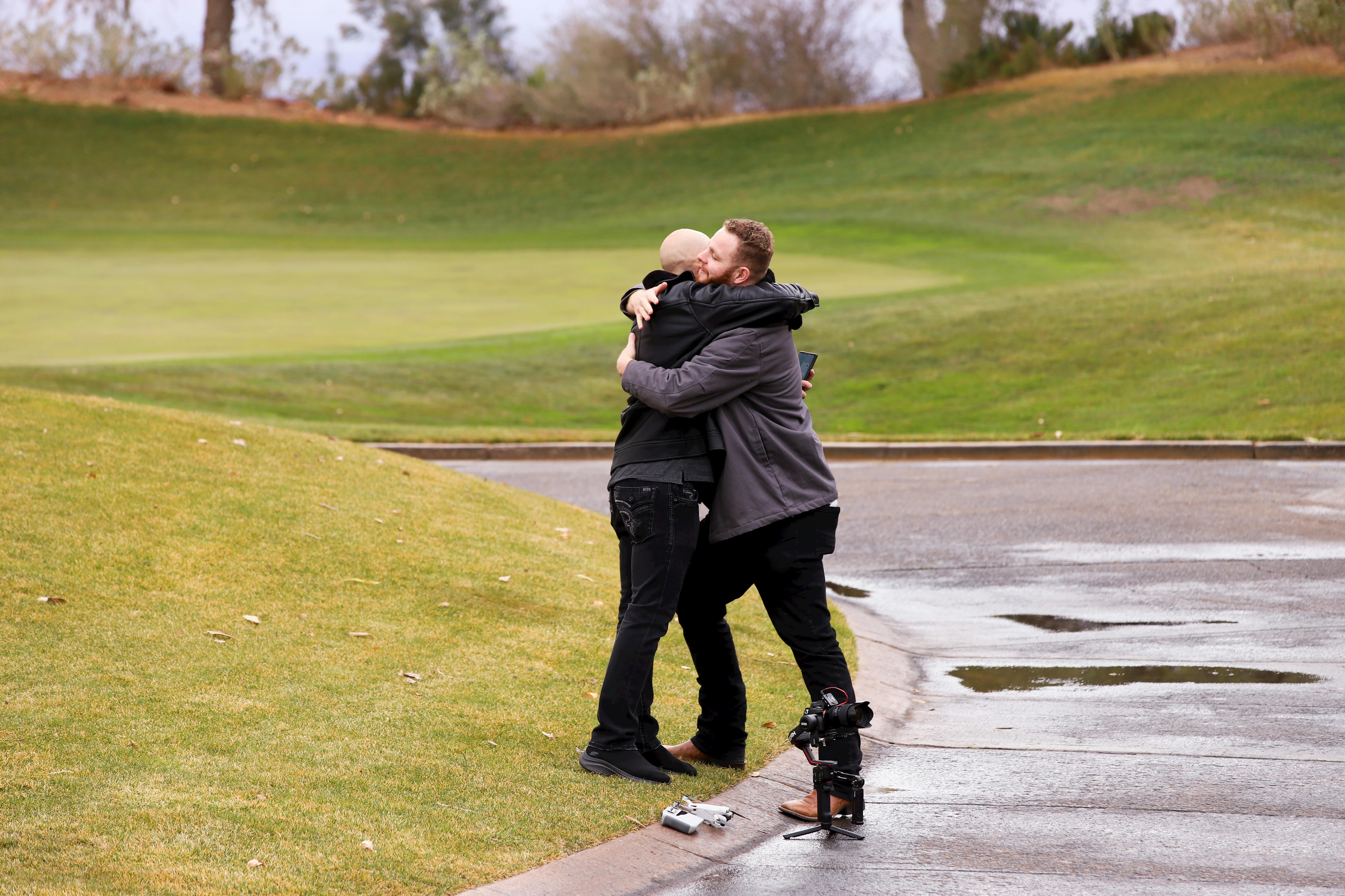 Two people hugging on the golf course · Free Stock Photo