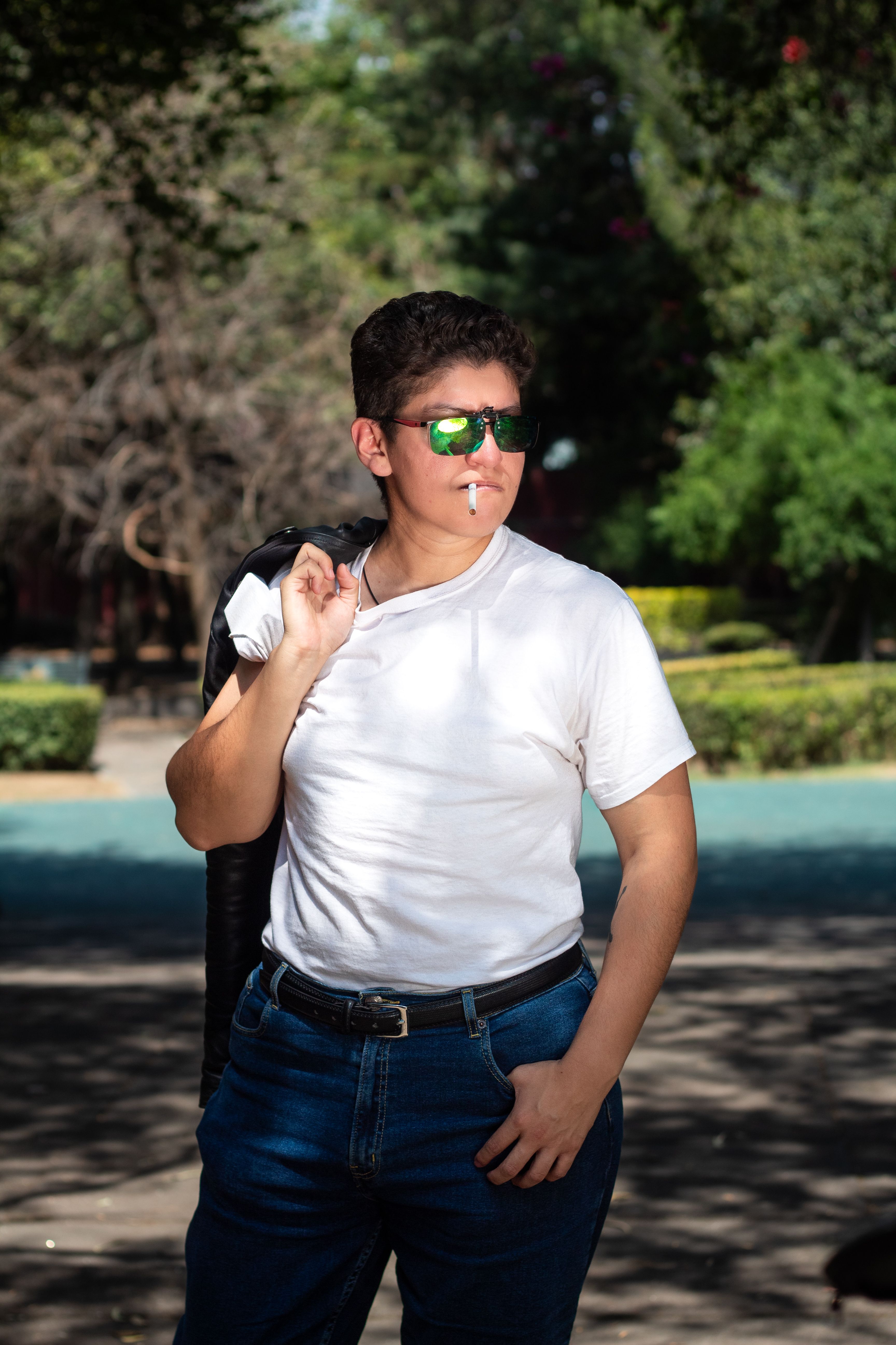 Model in Jeans Smoking Cigarette · Free Stock Photo