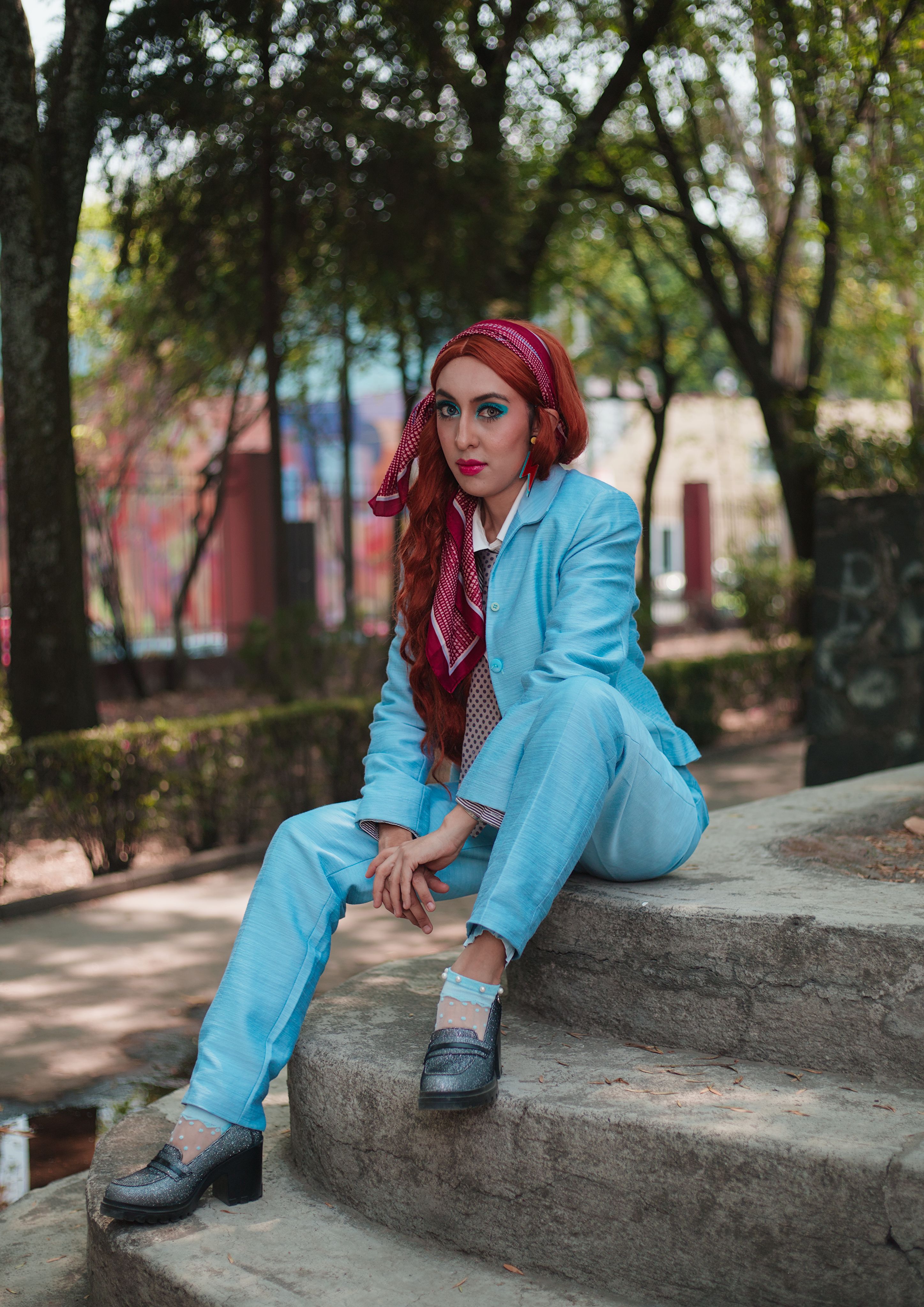 Redhead Woman Sitting on Stone Steps Wearing Light Blue Suit and ...