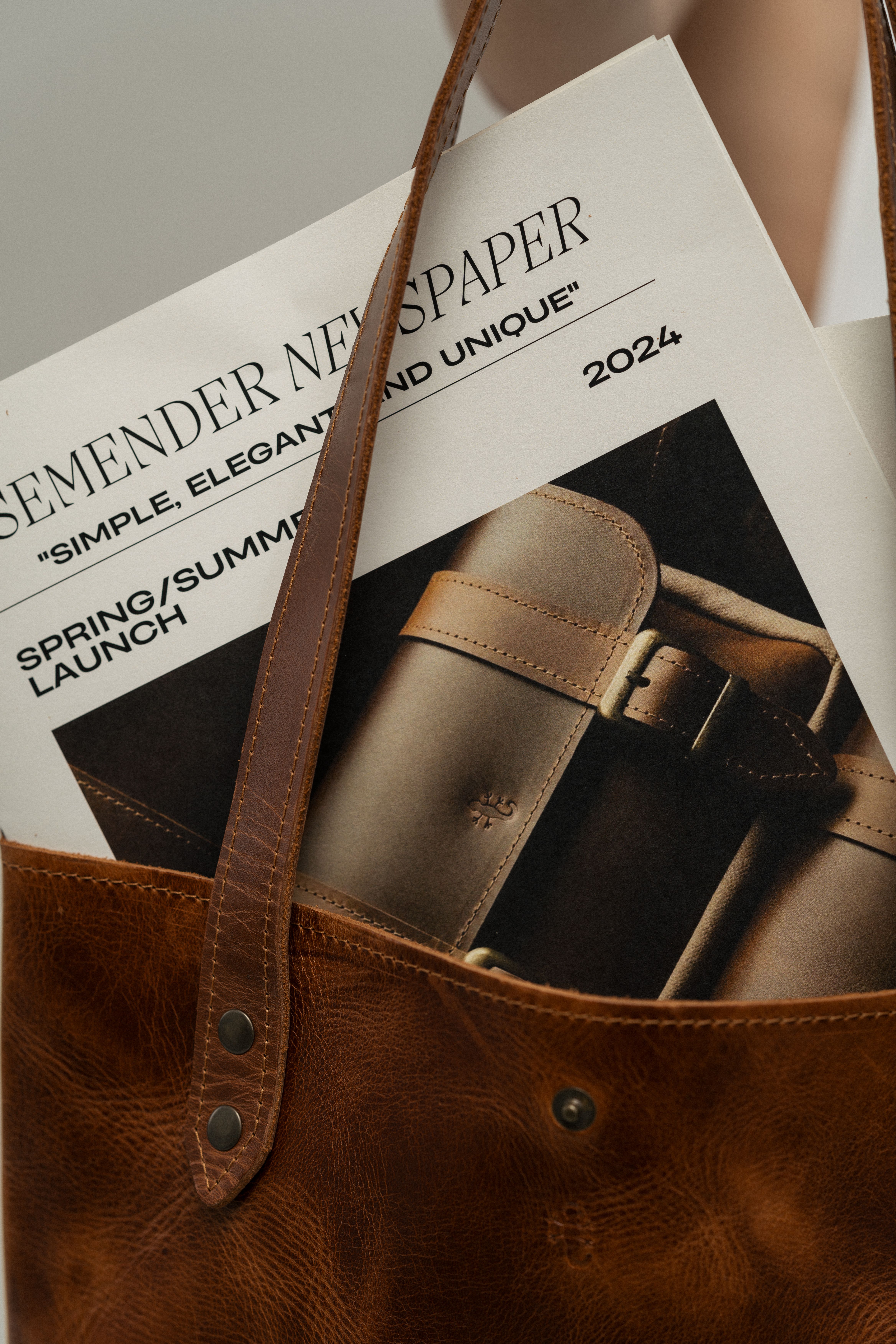 A brown leather tote bag with magazine · Free Stock Photo