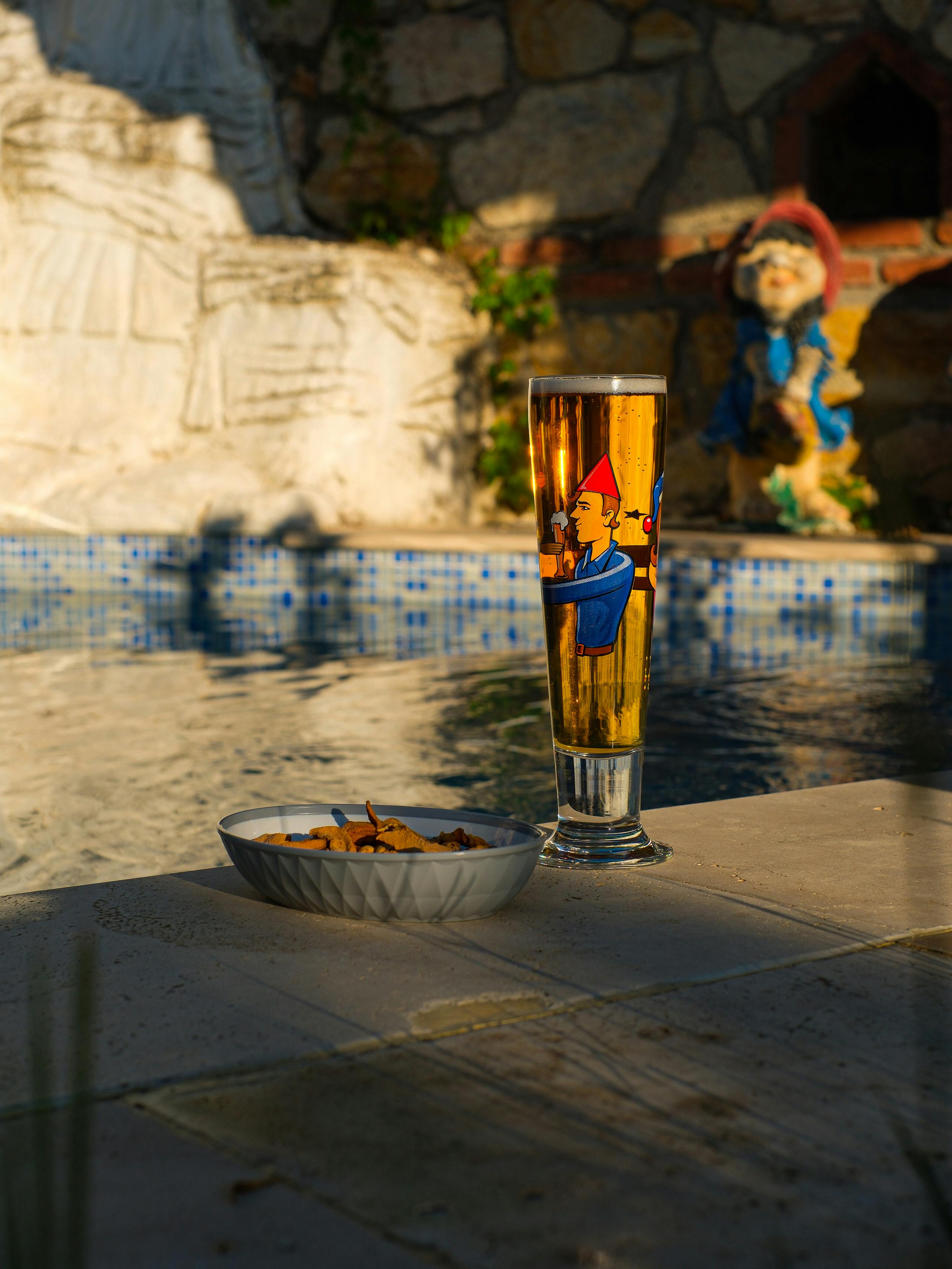 A Drink and a Snack Standing by the Swimming Pool · Free Stock Photo
