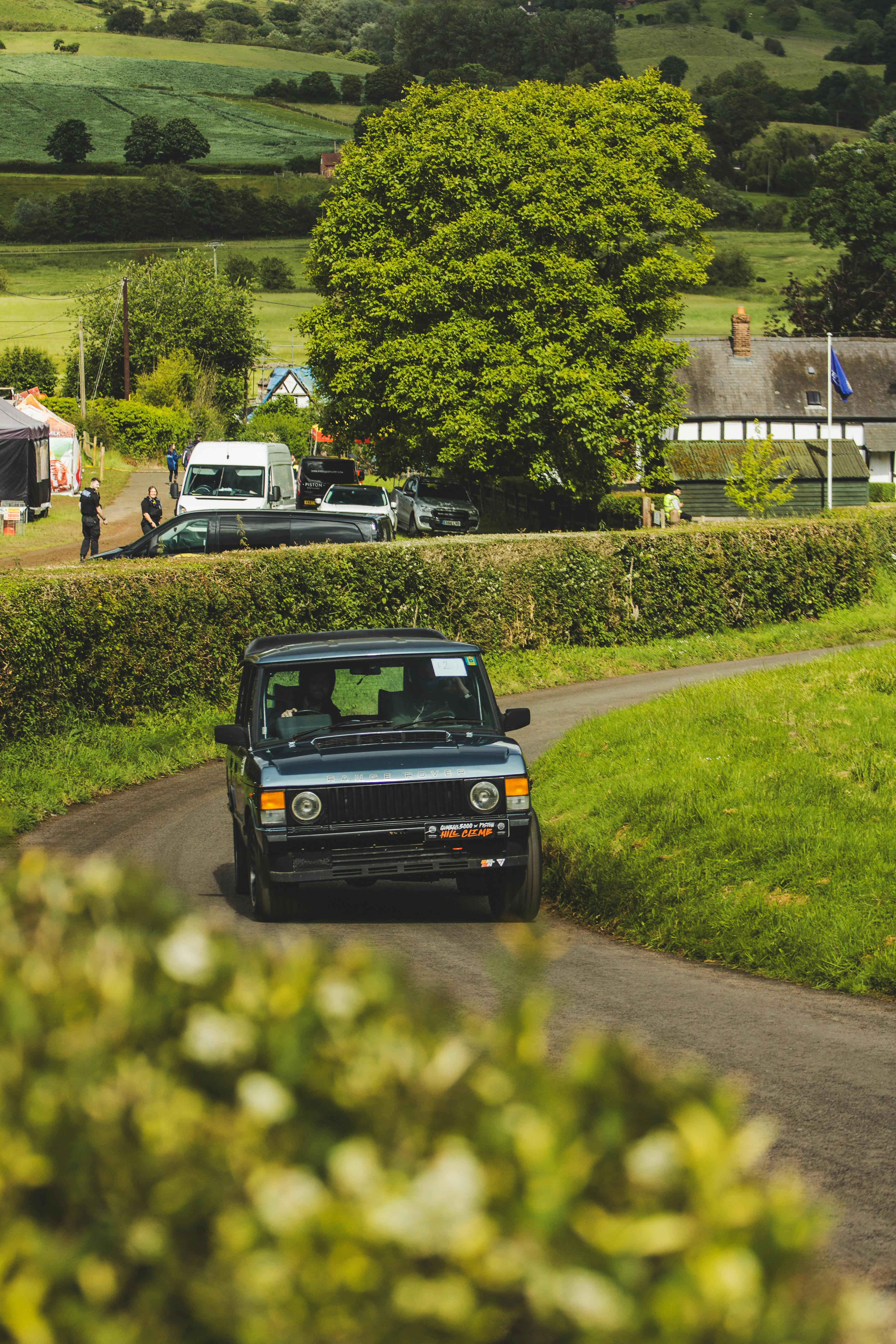 A Car Driving on a Dirt Road in the Countryside · Free Stock Photo
