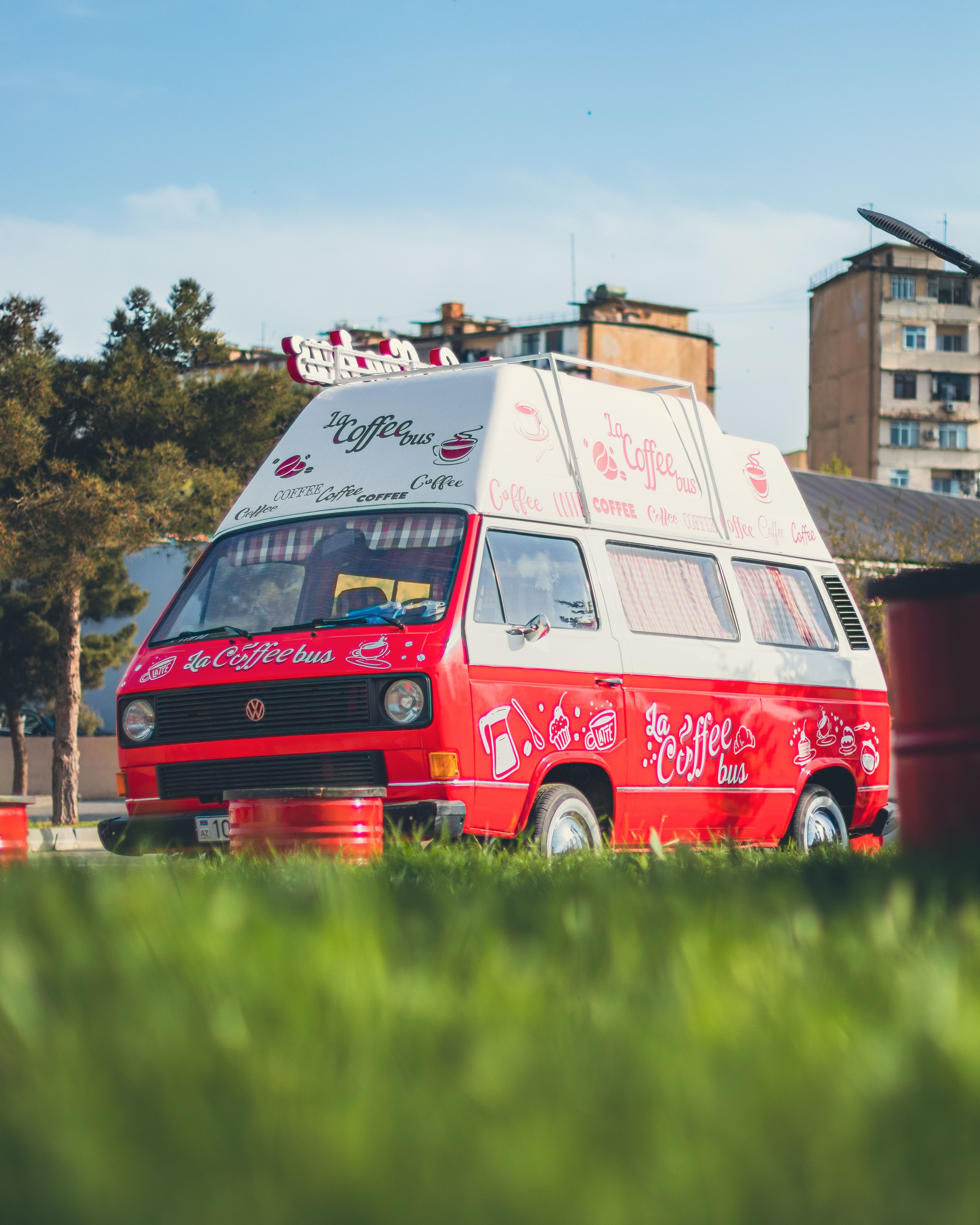 A red and white van parked in the grass · Free Stock Photo