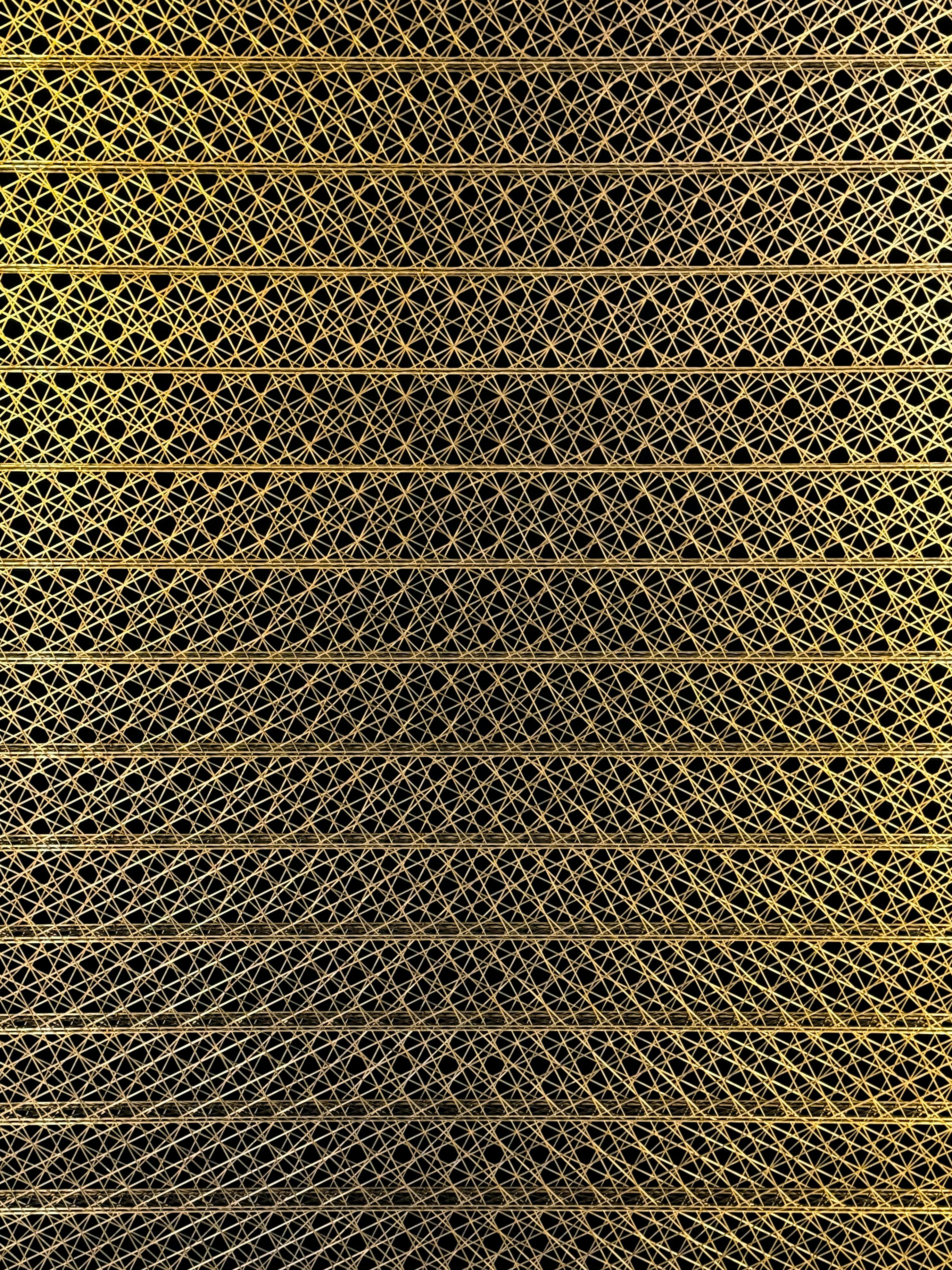 A gold metal mesh background with a pattern · Free Stock Photo
