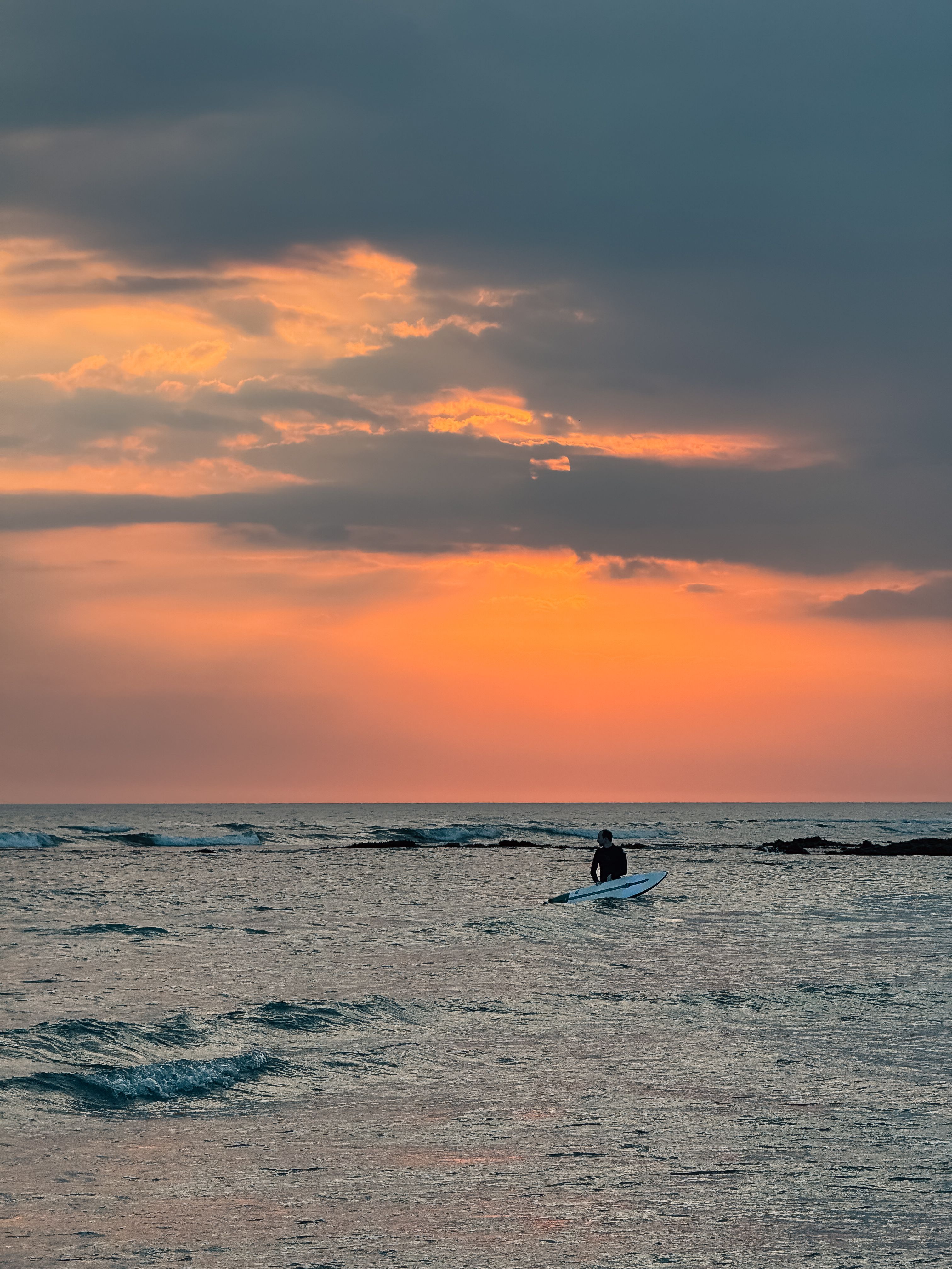 Surfer Wading in Sea at Dawn · Free Stock Photo