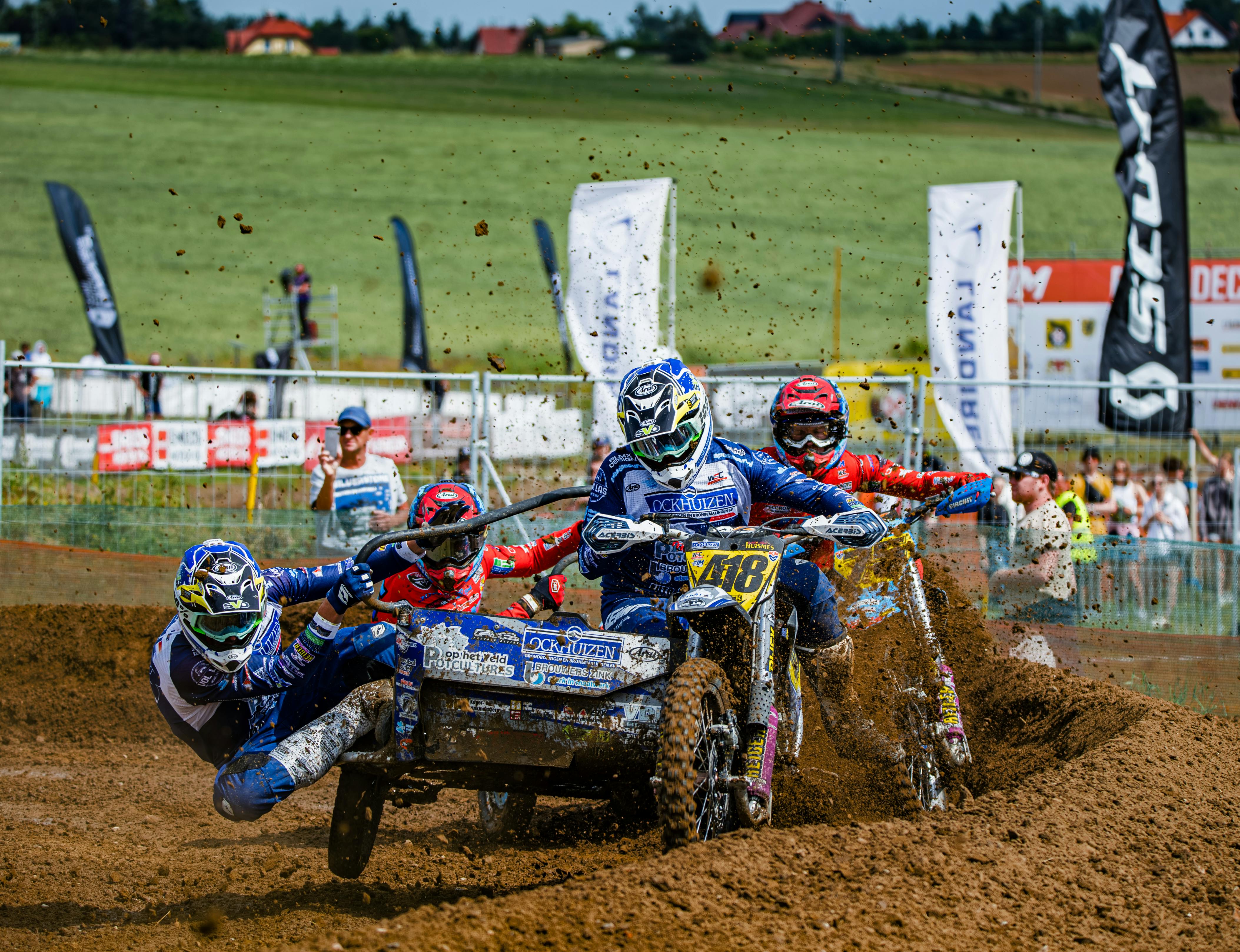 Sidecar Motocross Teams on the Bend of the Track · Free Stock Photo