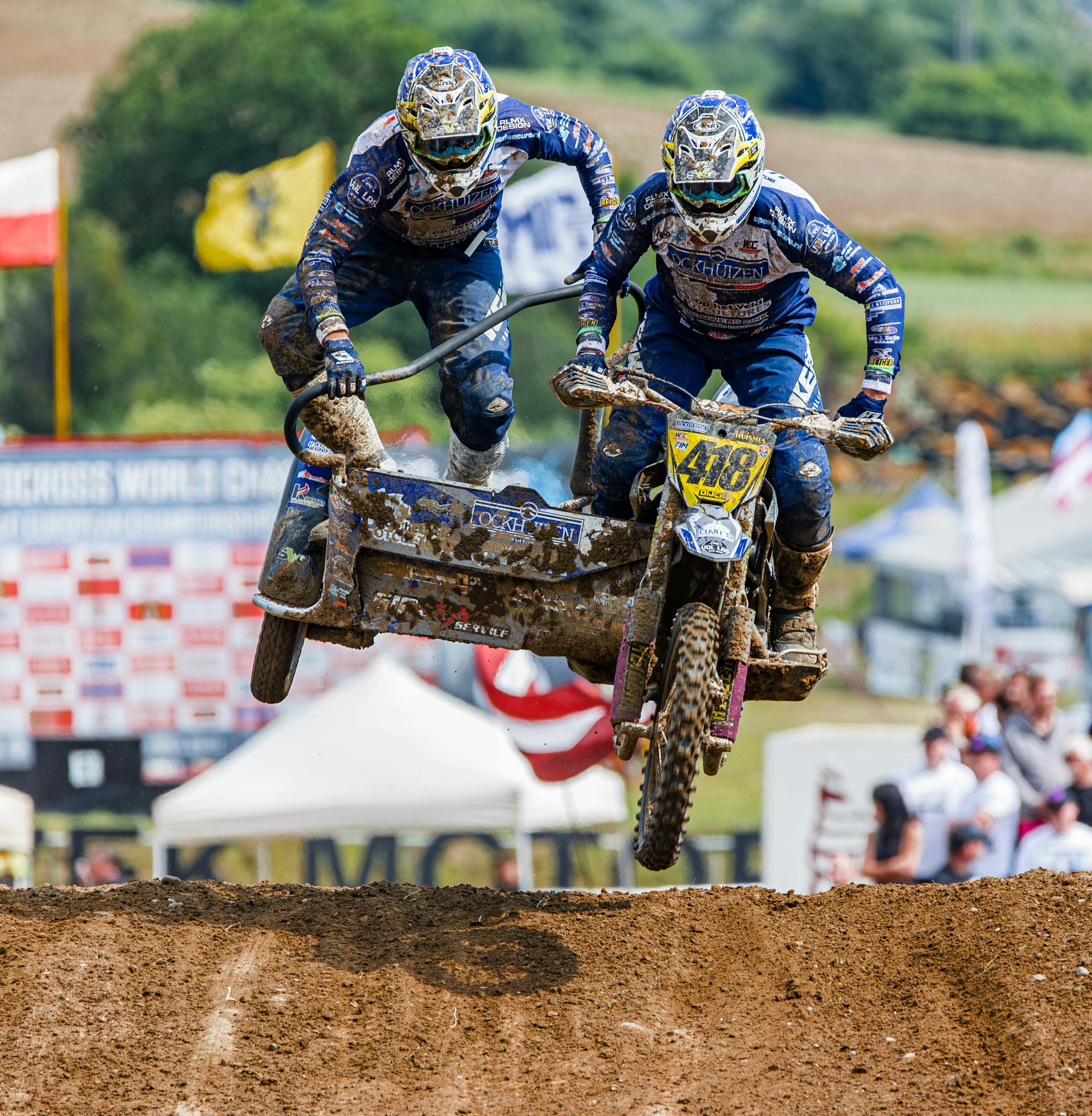 Two people riding dirt bikes · Free Stock Photo