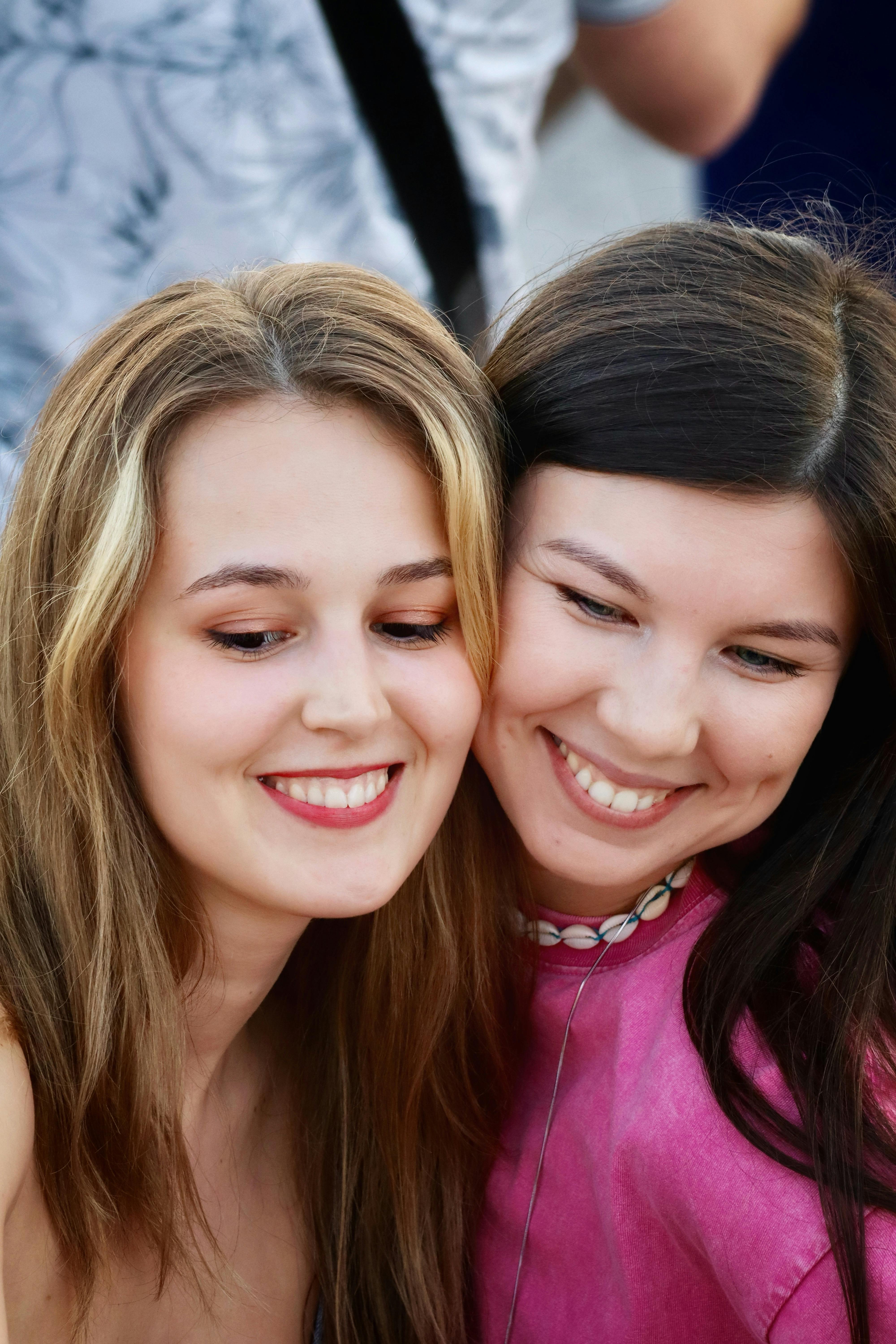 Smiling Women Cheek to Cheek · Free Stock Photo
