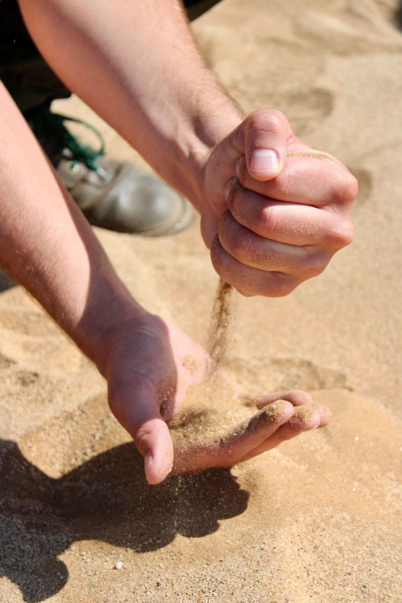 Pouring Sand From Hand to Hand · Free Stock Photo