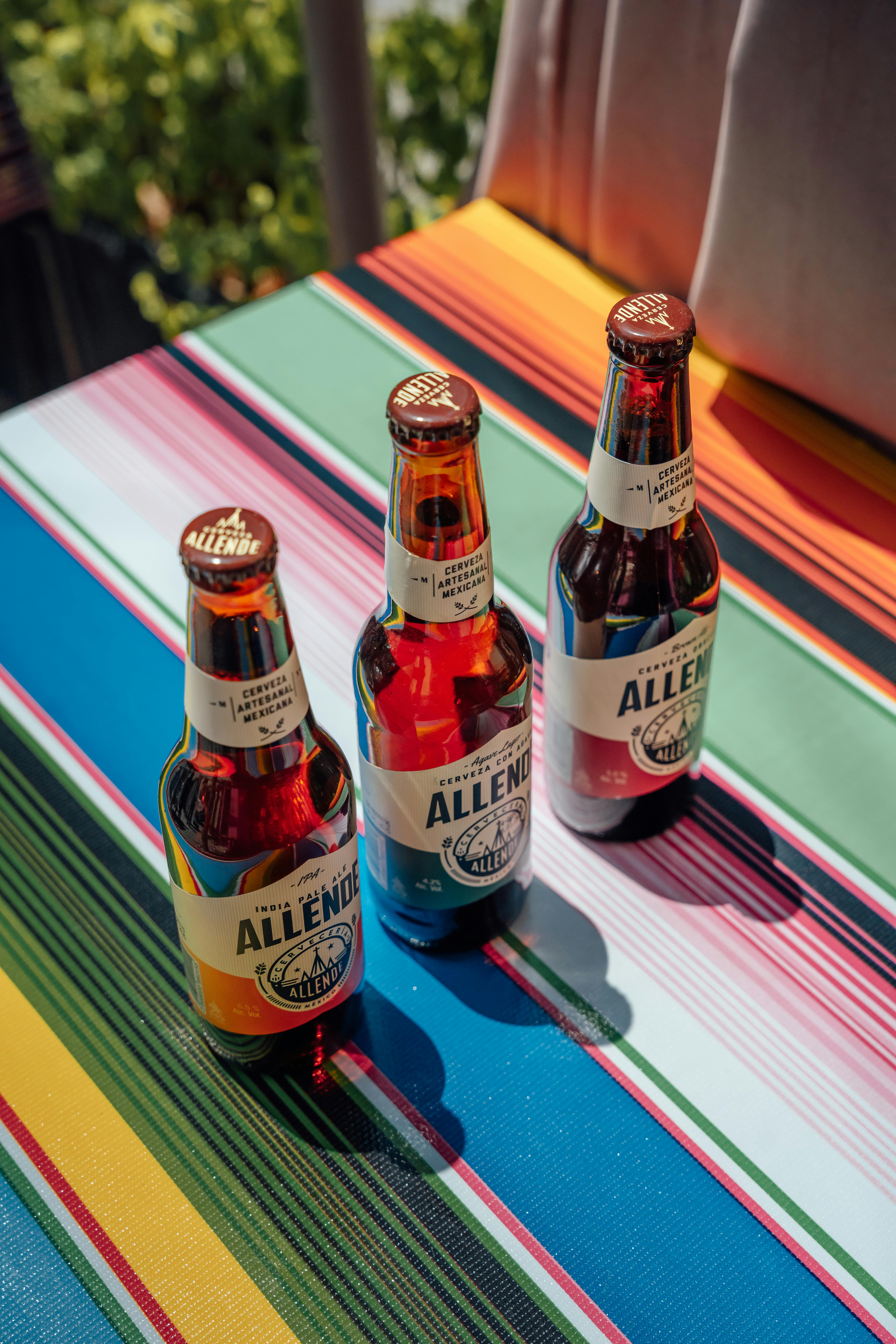 Bottles of Beer on Colorful Table · Free Stock Photo