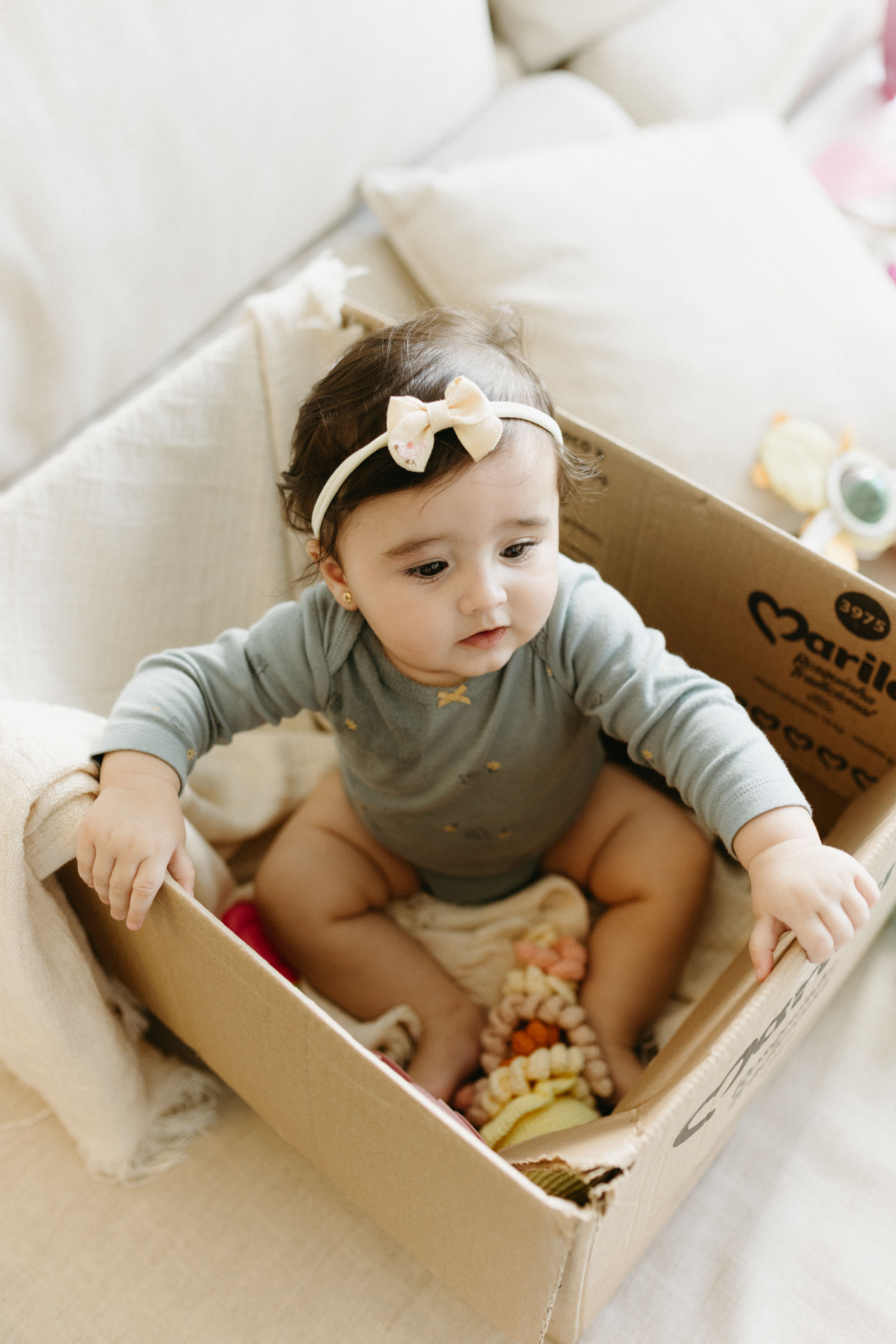 Baby Girl Sitting in Cardboard Box · Free Stock Photo