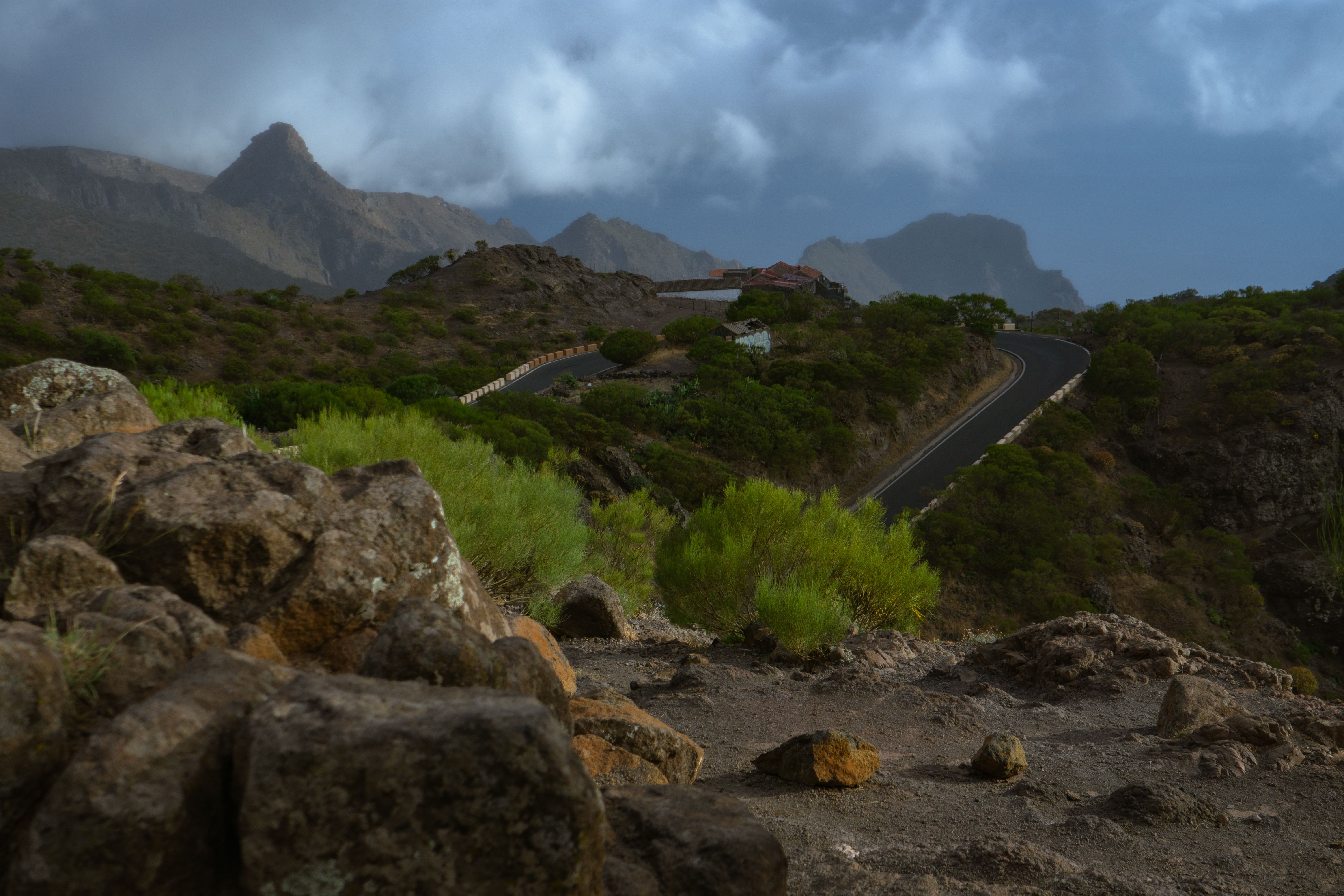 Rocks and Road in Mountains behind · Free Stock Photo