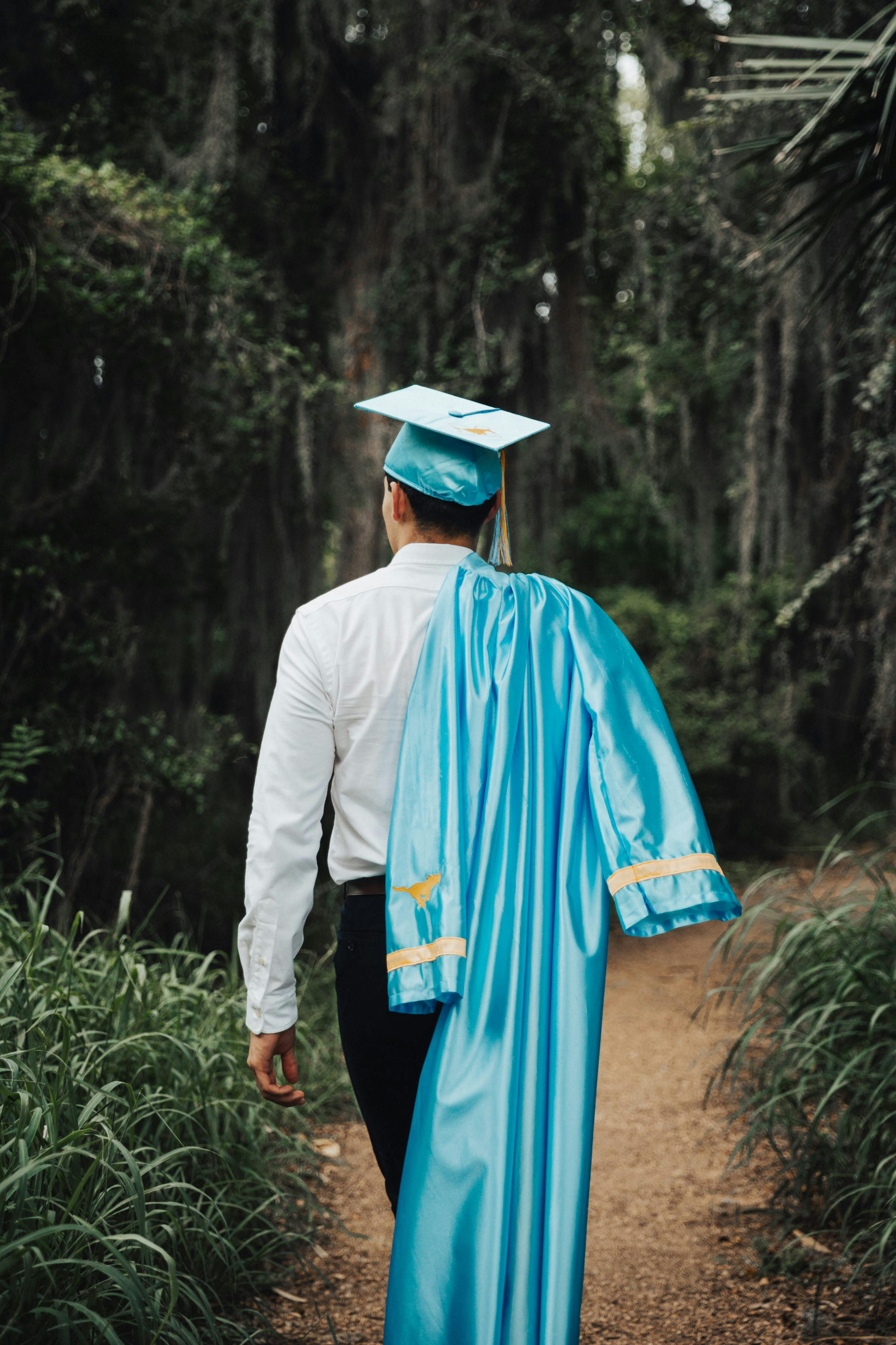 Back View of Man in Academic Hat Walking with Gown in Forest · Free ...
