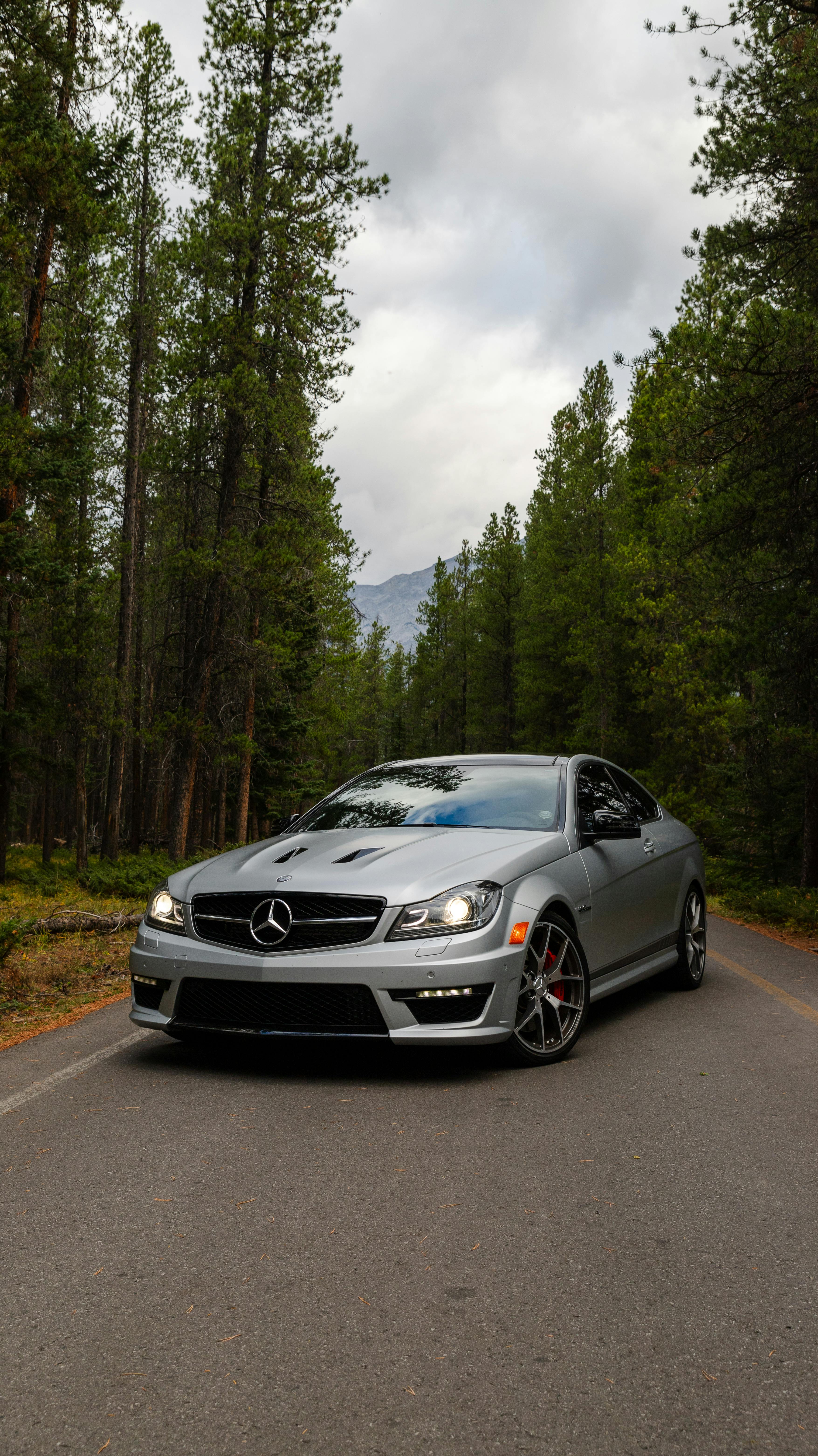 A Mercedes-Benz C63 AMG Parked on the Street between the Trees · Free ...