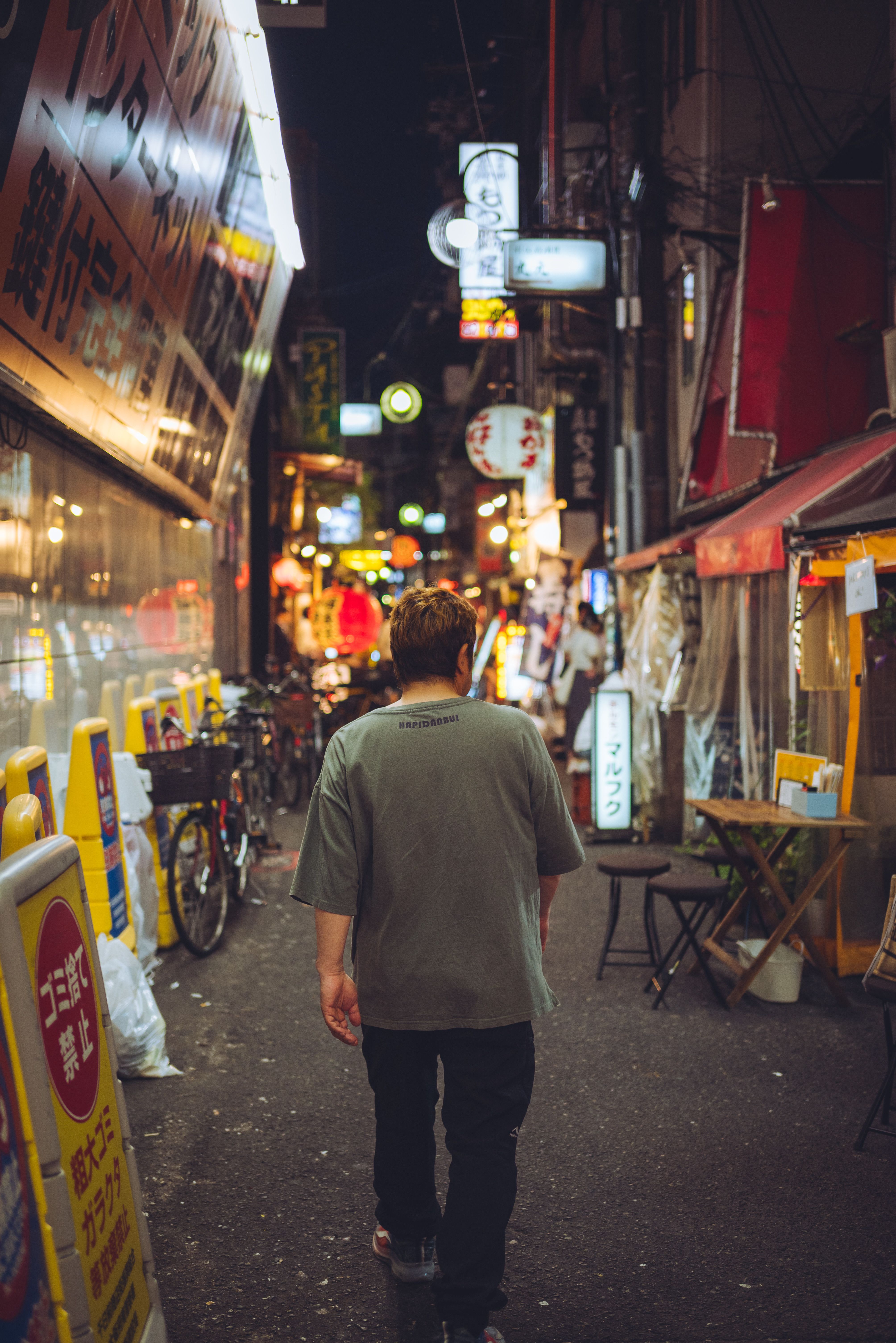 Back View of a Man Walking on the Illuminated Street at Night · Free ...