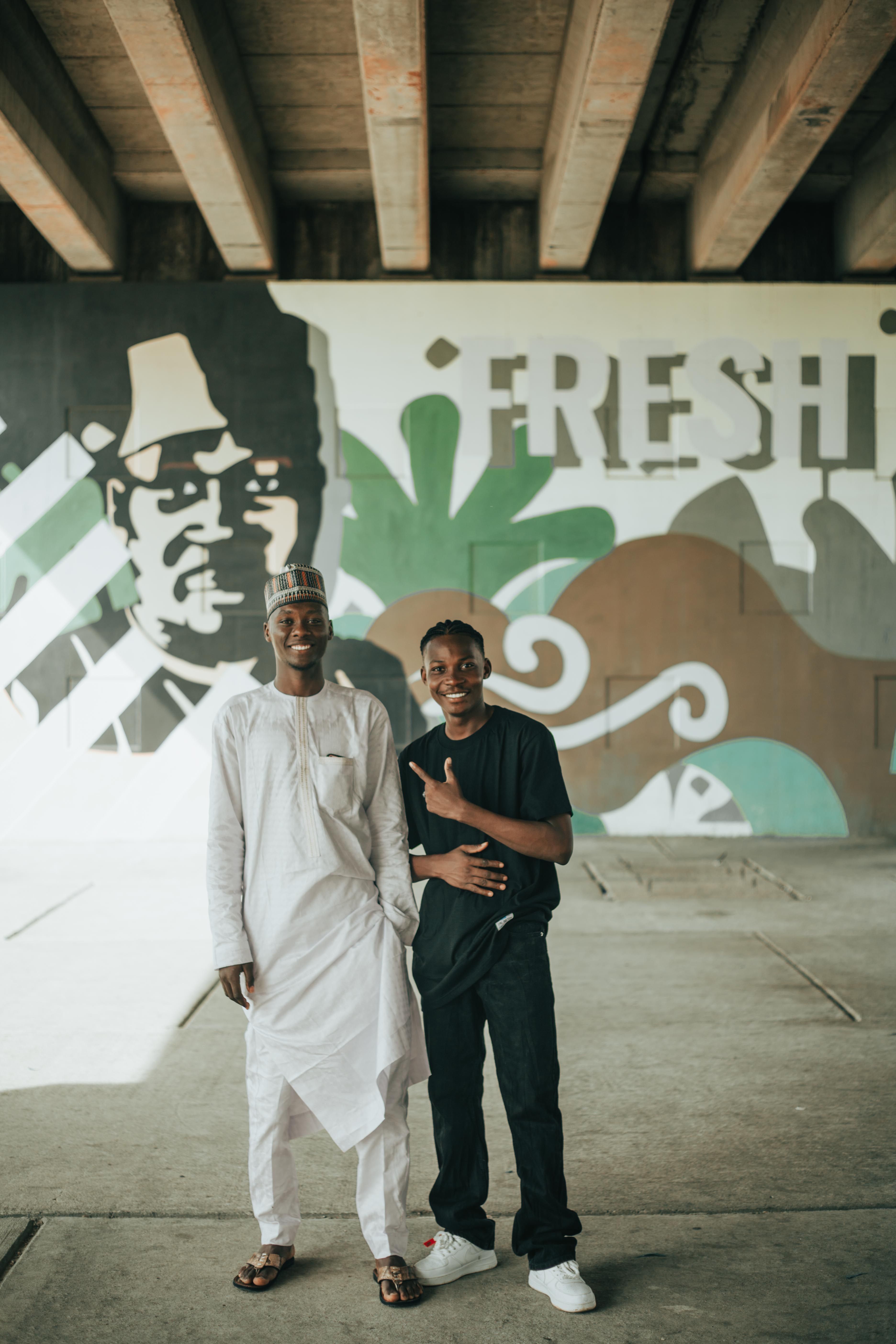 Smiling Men with Mural behind · Free Stock Photo