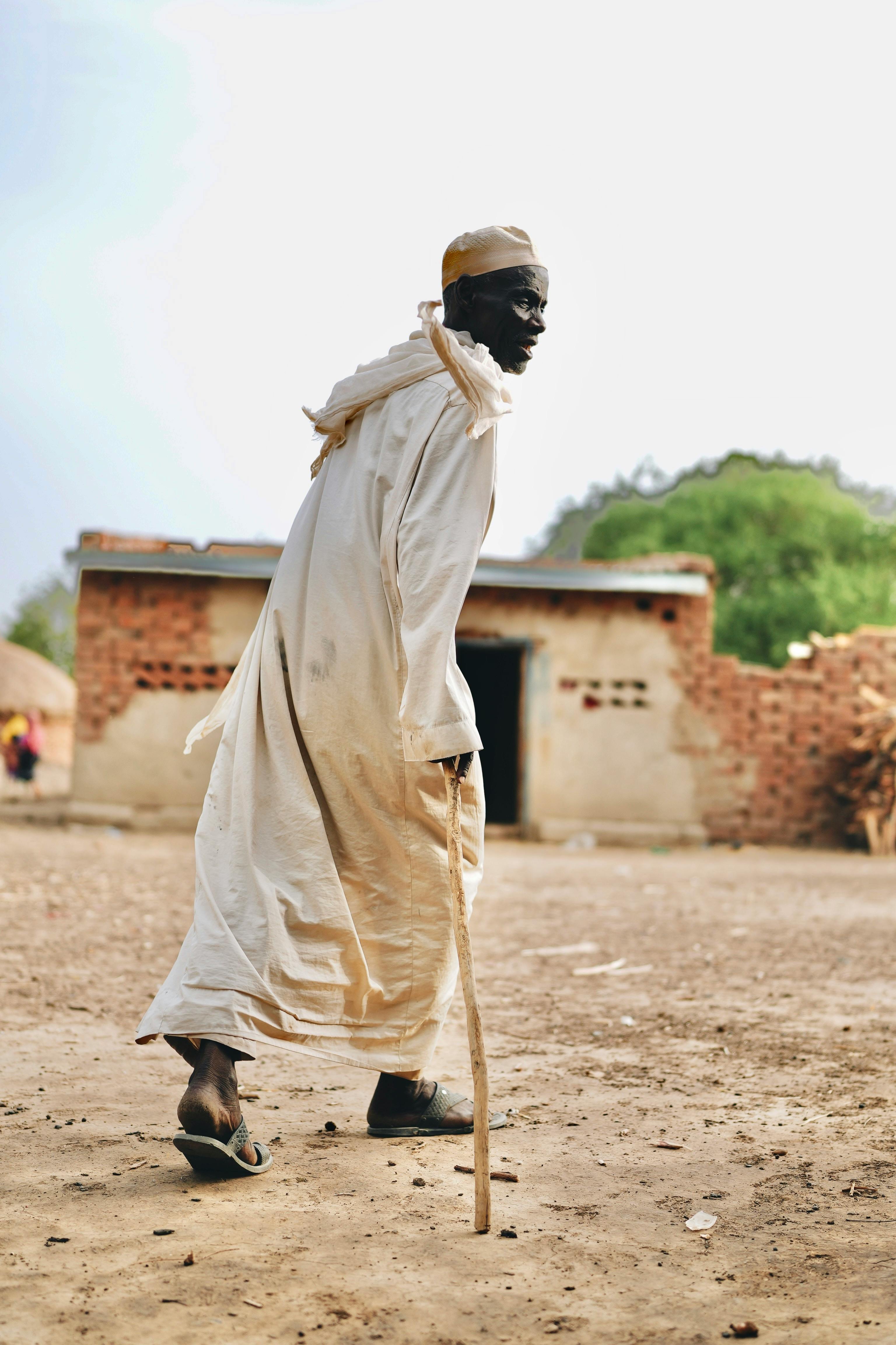 Man Walking with a Stick · Free Stock Photo