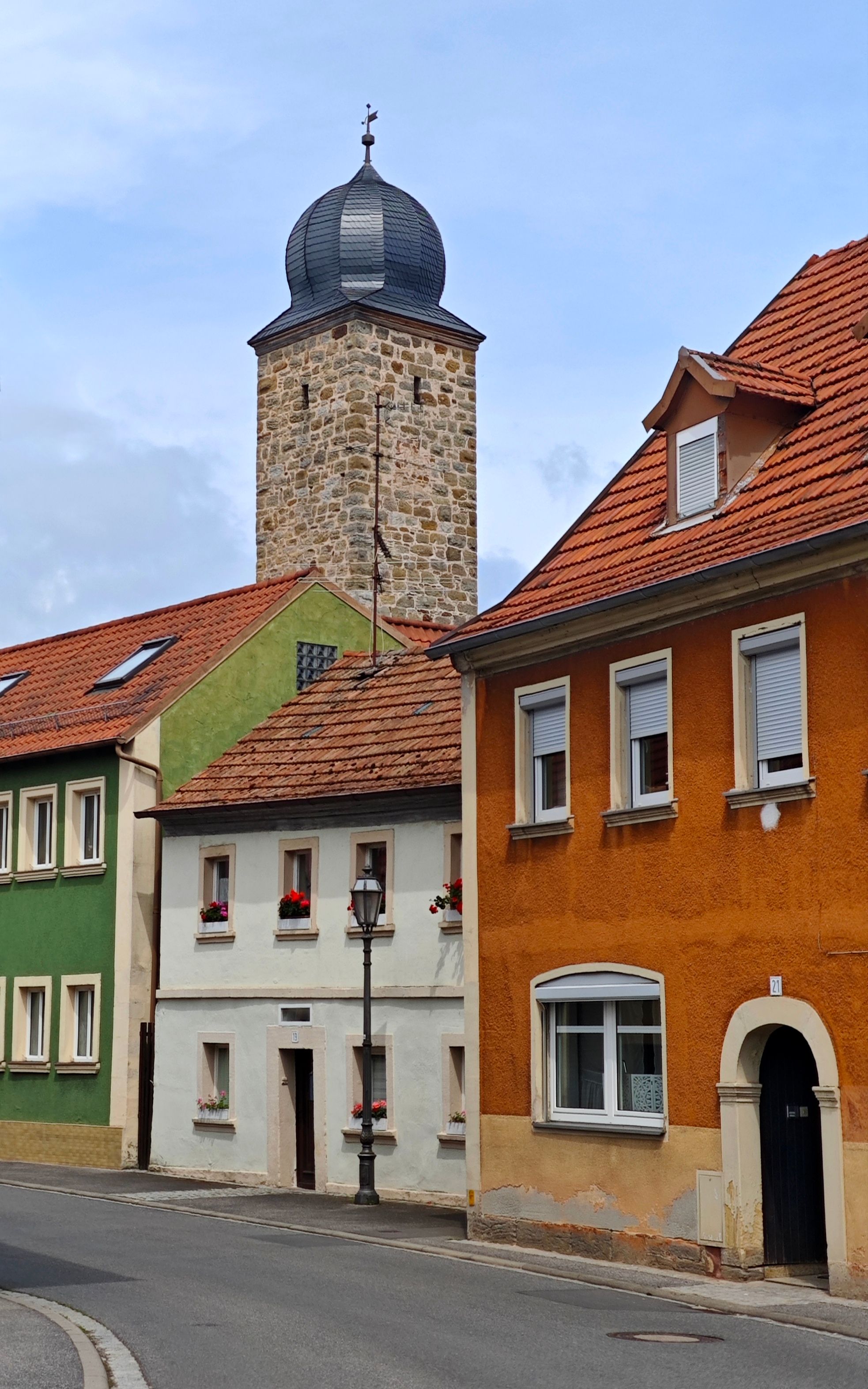 Small Stone Church Tower behind Terraced Houses in Town · Free Stock Photo