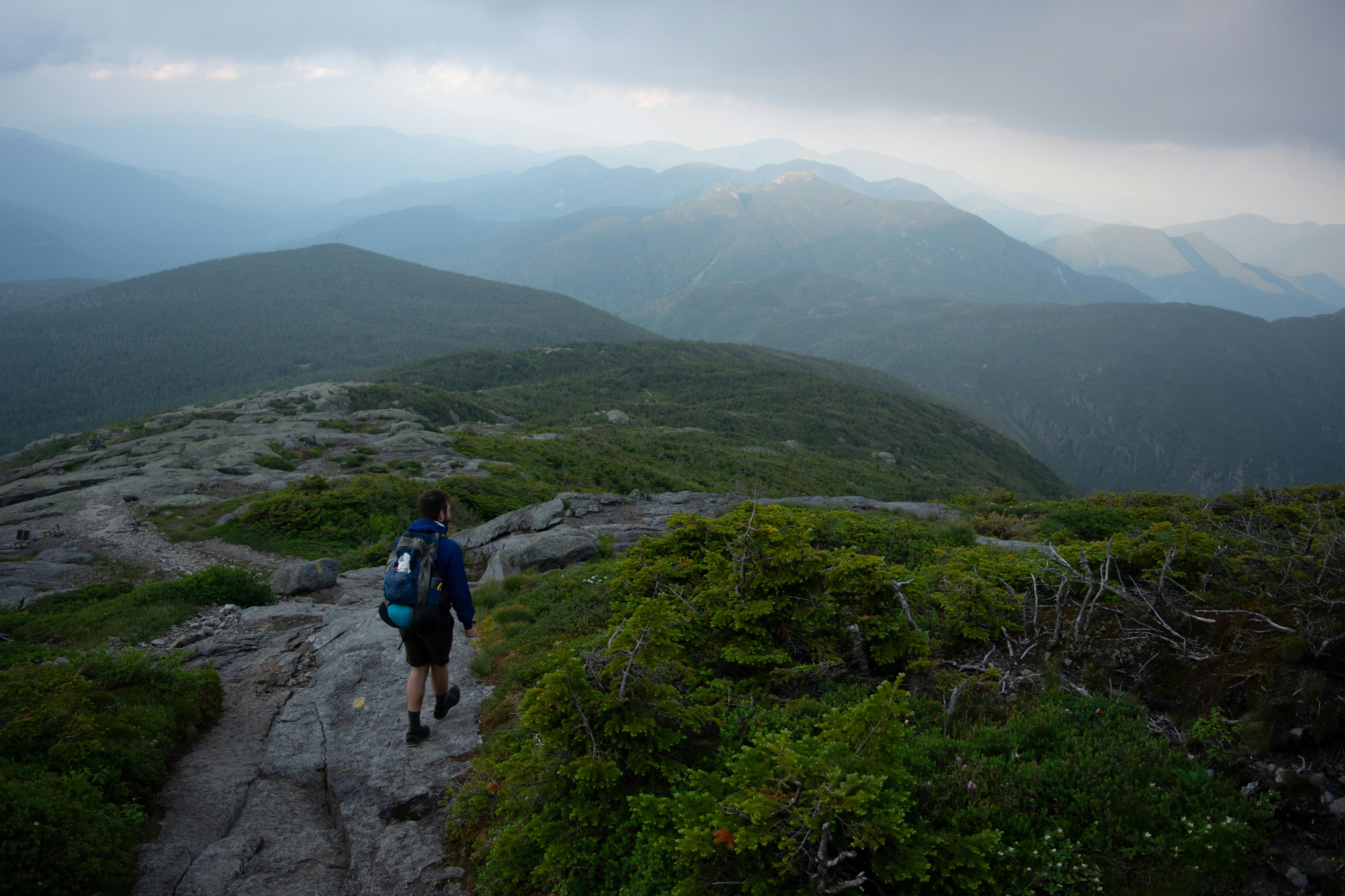 Man on a Path in a Mountain Valley · Free Stock Photo