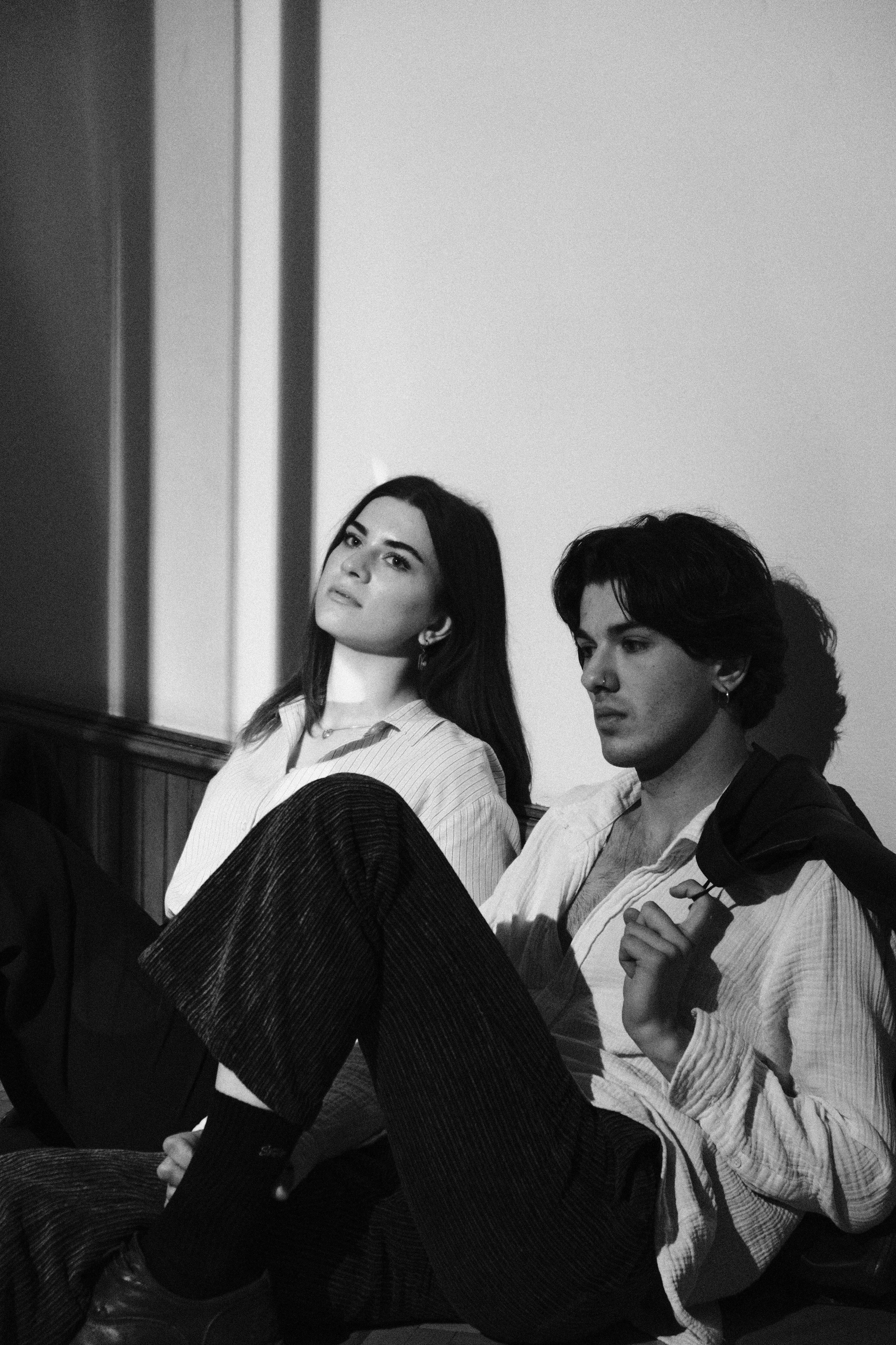 Sitting Couple Leaning Back on Wall · Free Stock Photo