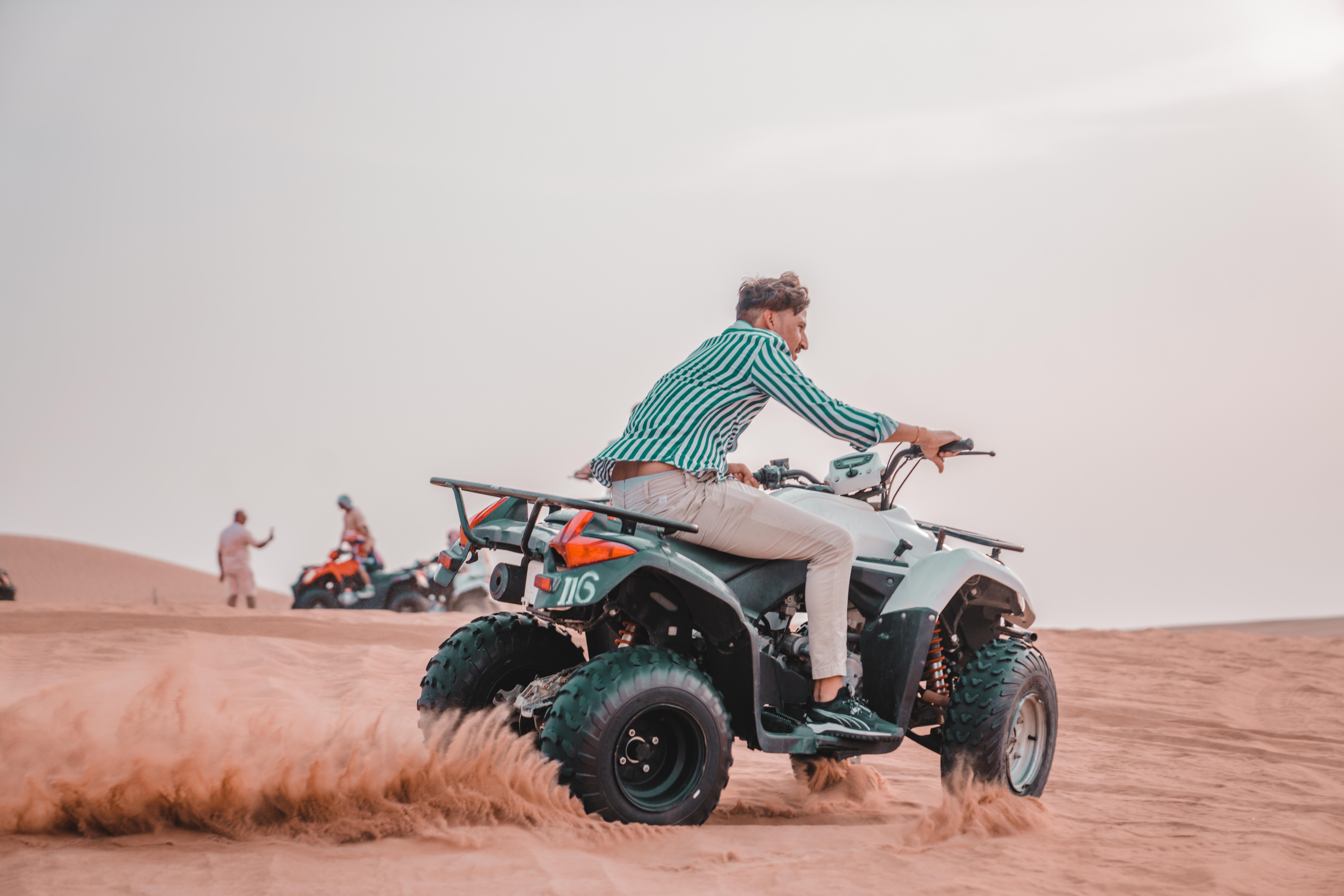 Man and People on Quads on Desert · Free Stock Photo
