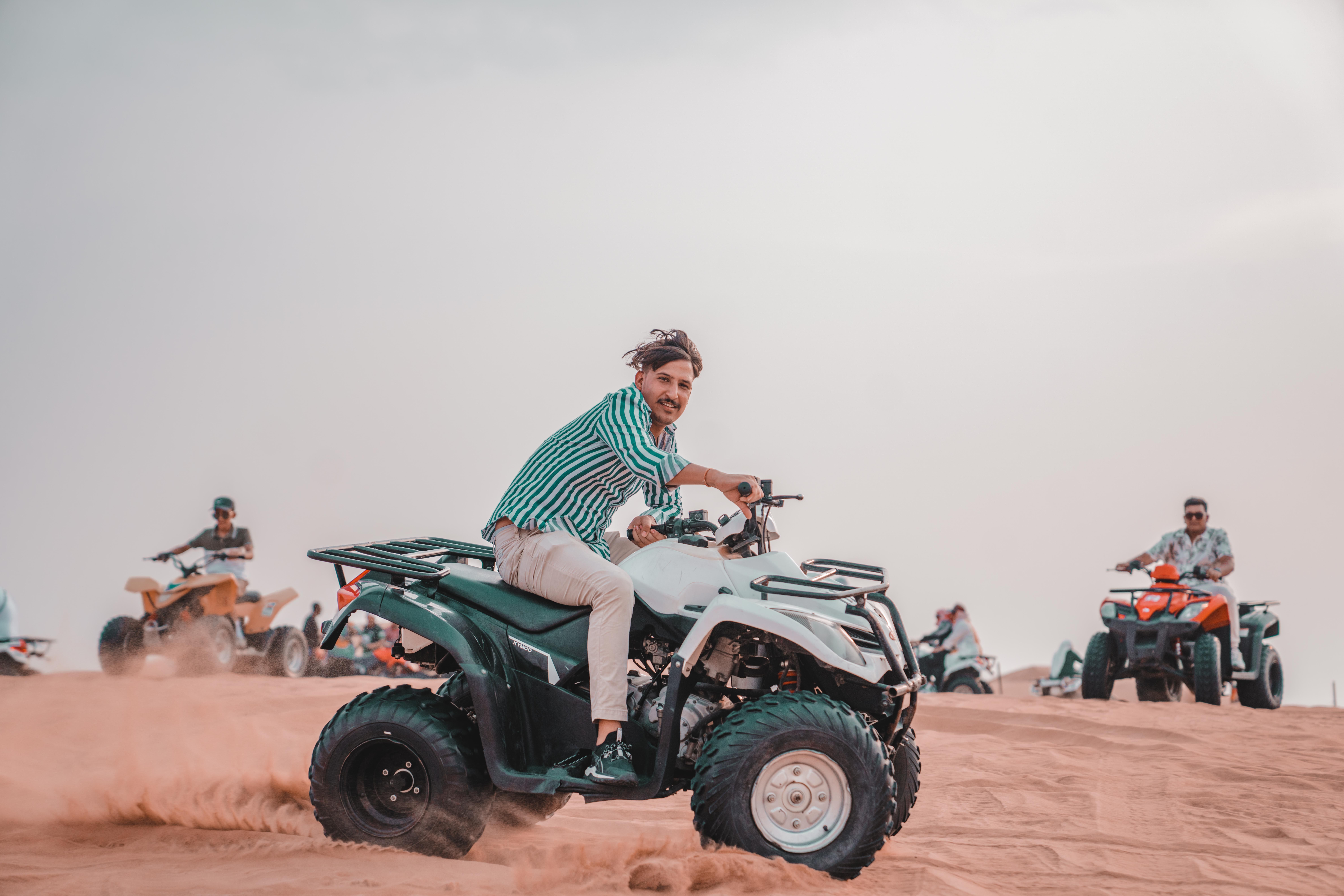 Man and People on Quads on Desert · Free Stock Photo