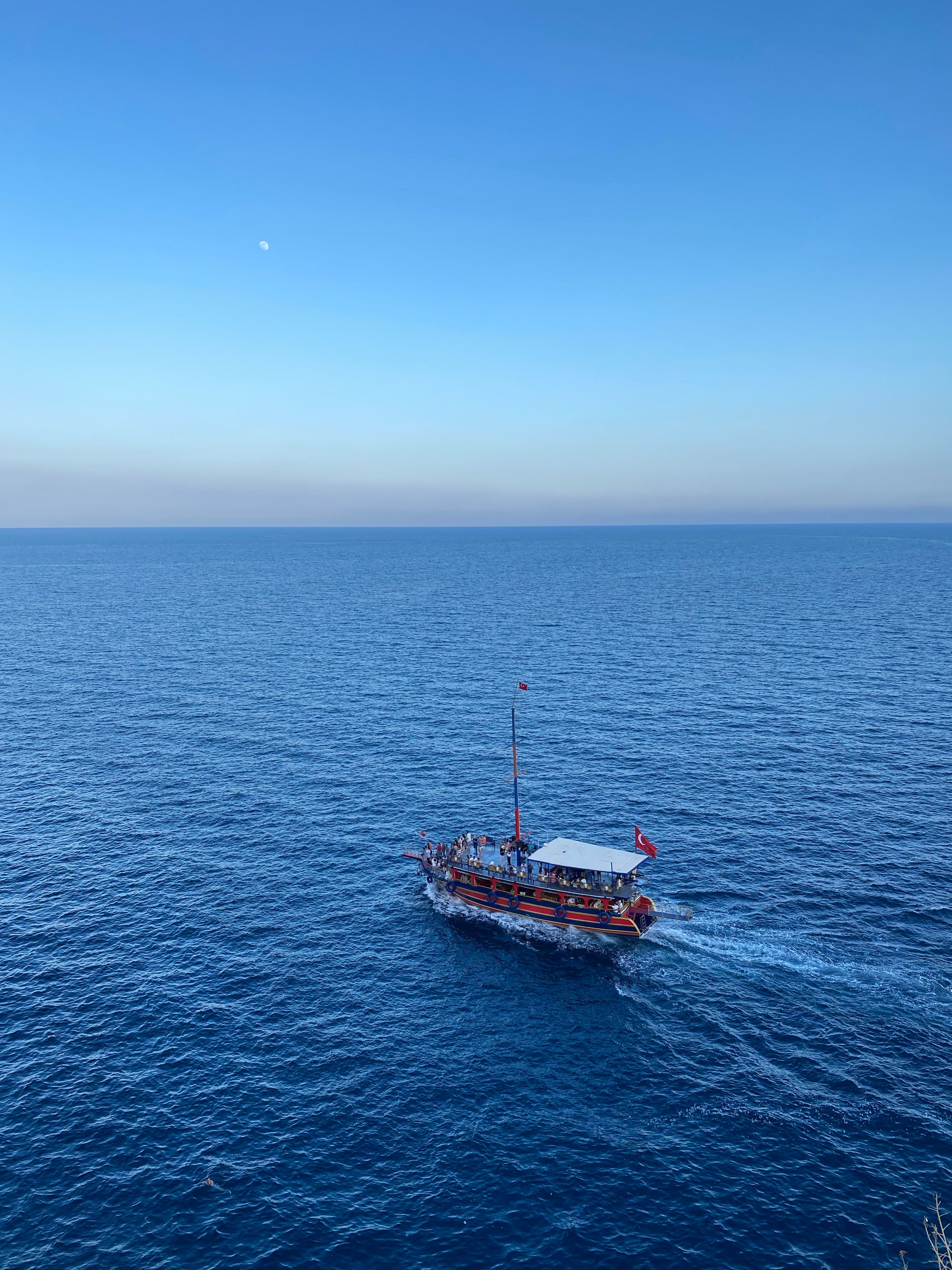 Small Tour Boat with People and Turkish Flag on Sea · Free Stock Photo