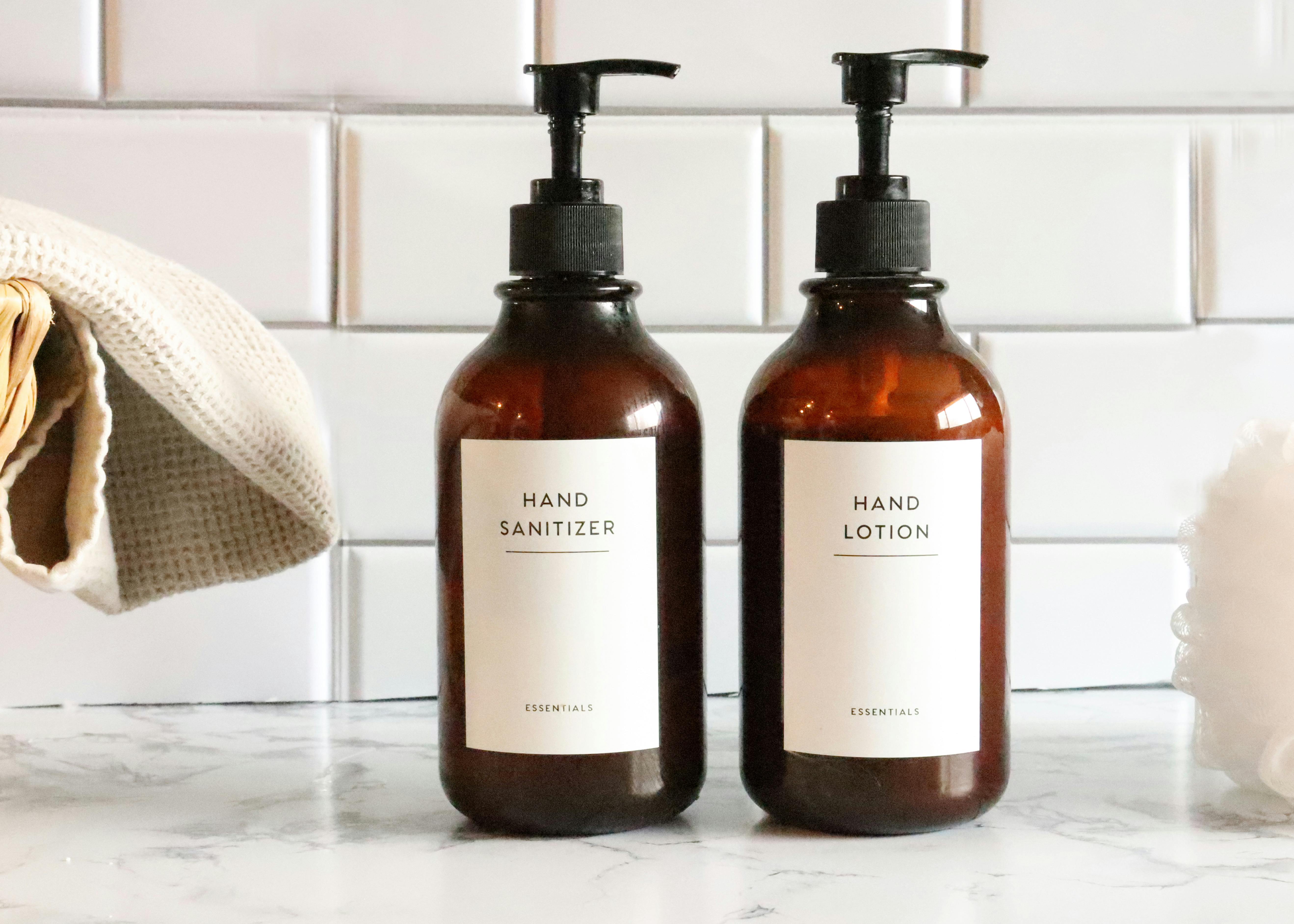 Two bottles of hand soap sitting on a counter · Free Stock Photo
