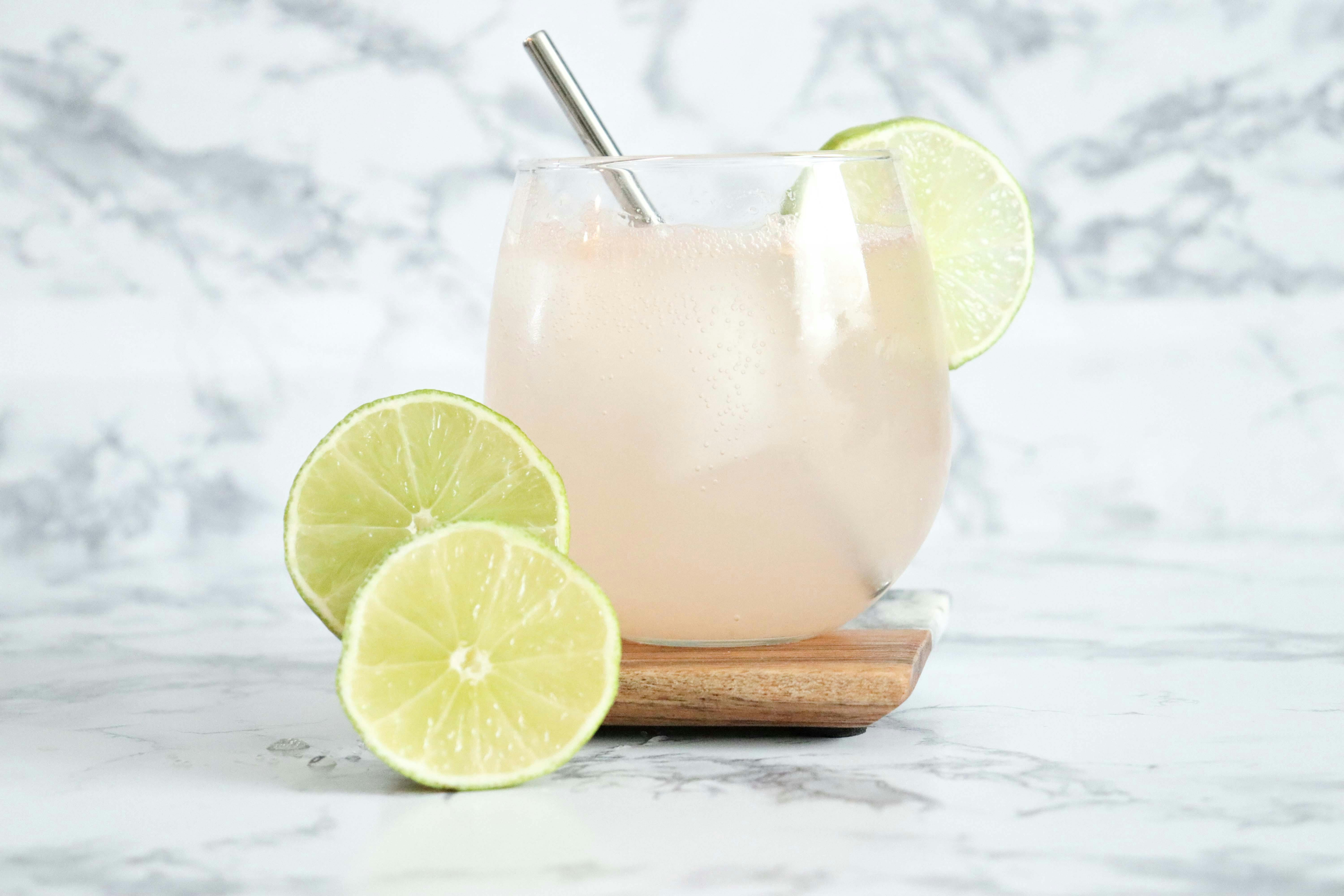 Lime Slices by Cockail in Glass with Straw · Free Stock Photo