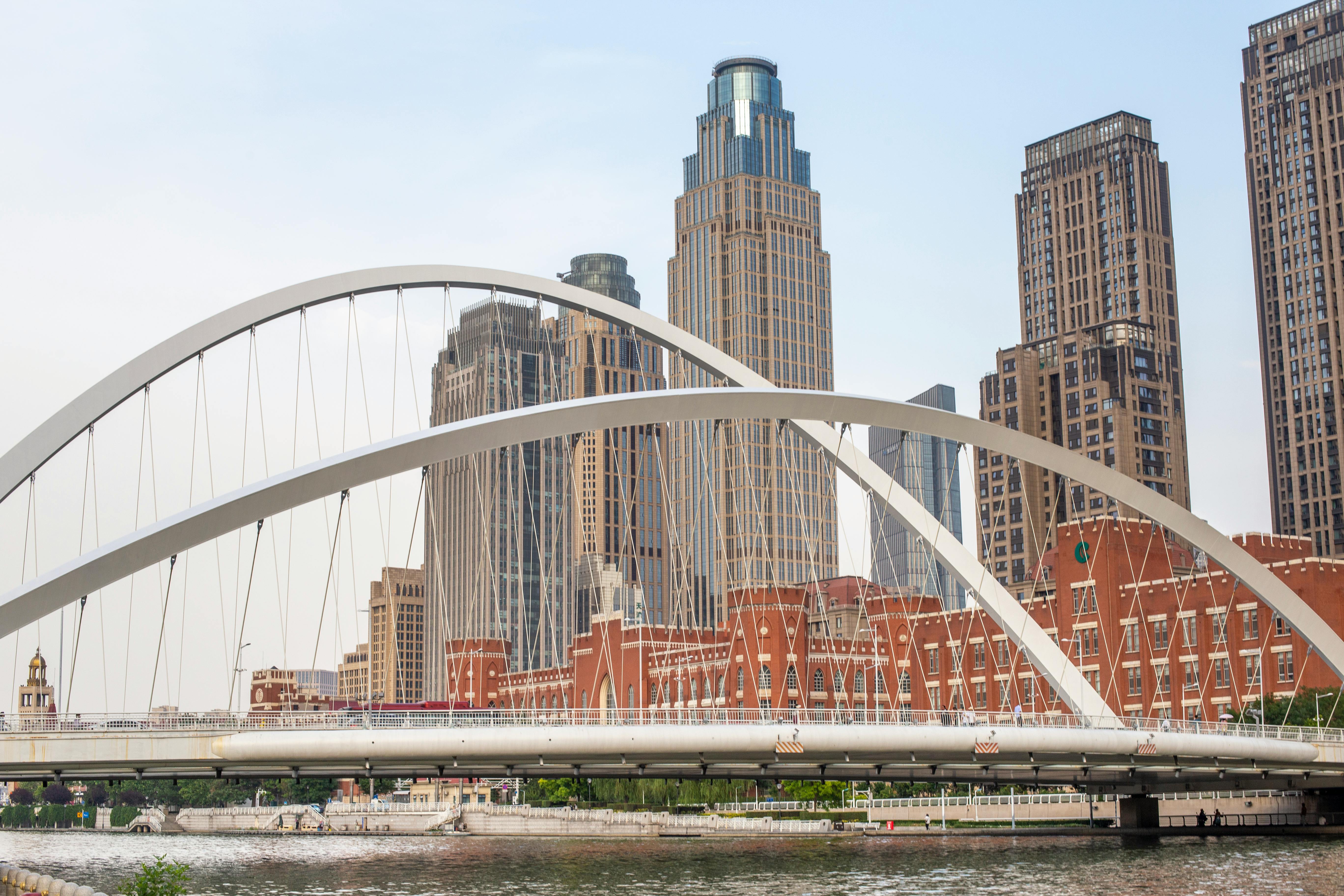 Suspension Bridge in Front of Skyscrapers · Free Stock Photo
