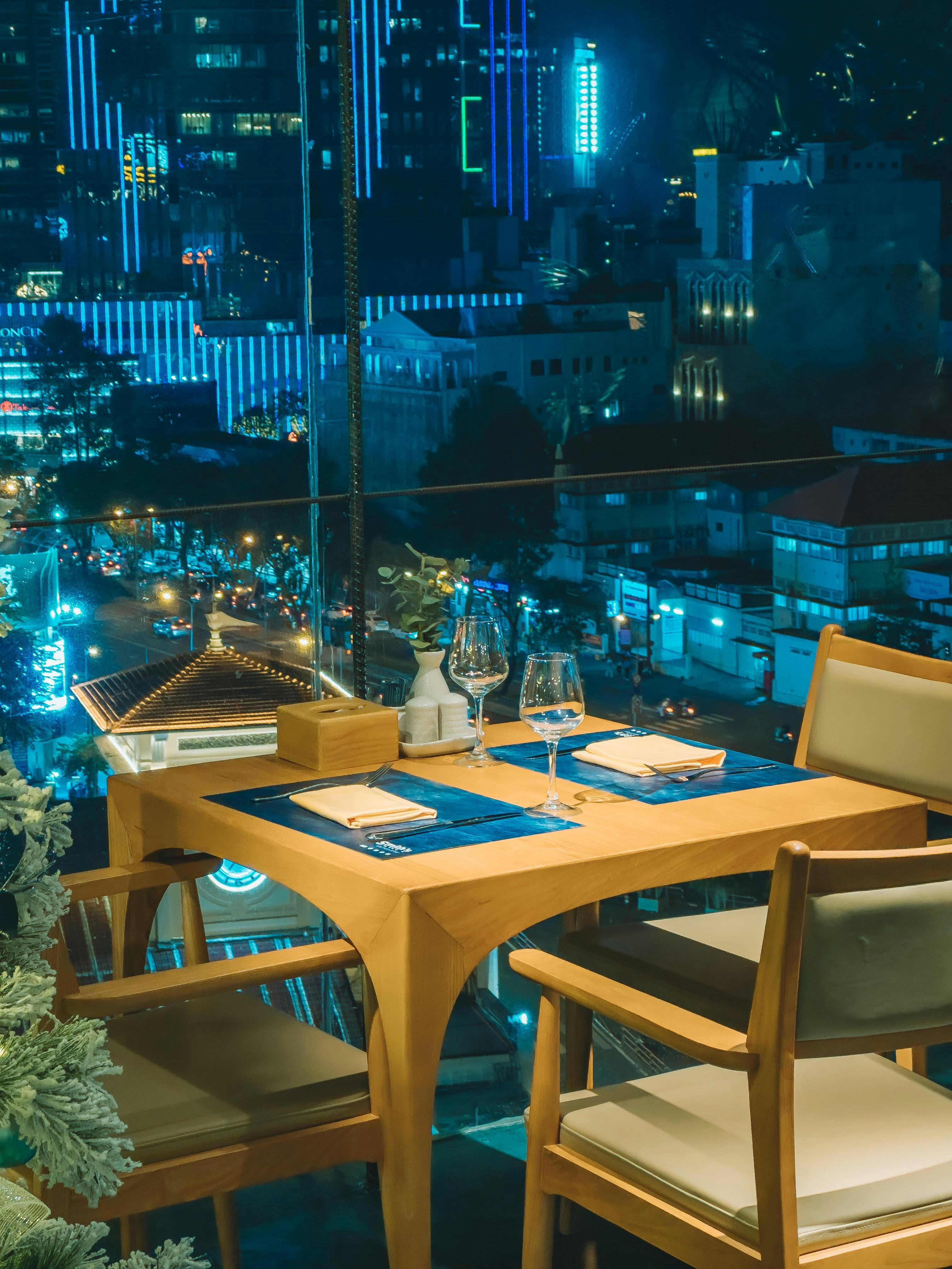 A restaurant table with a view of the city · Free Stock Photo