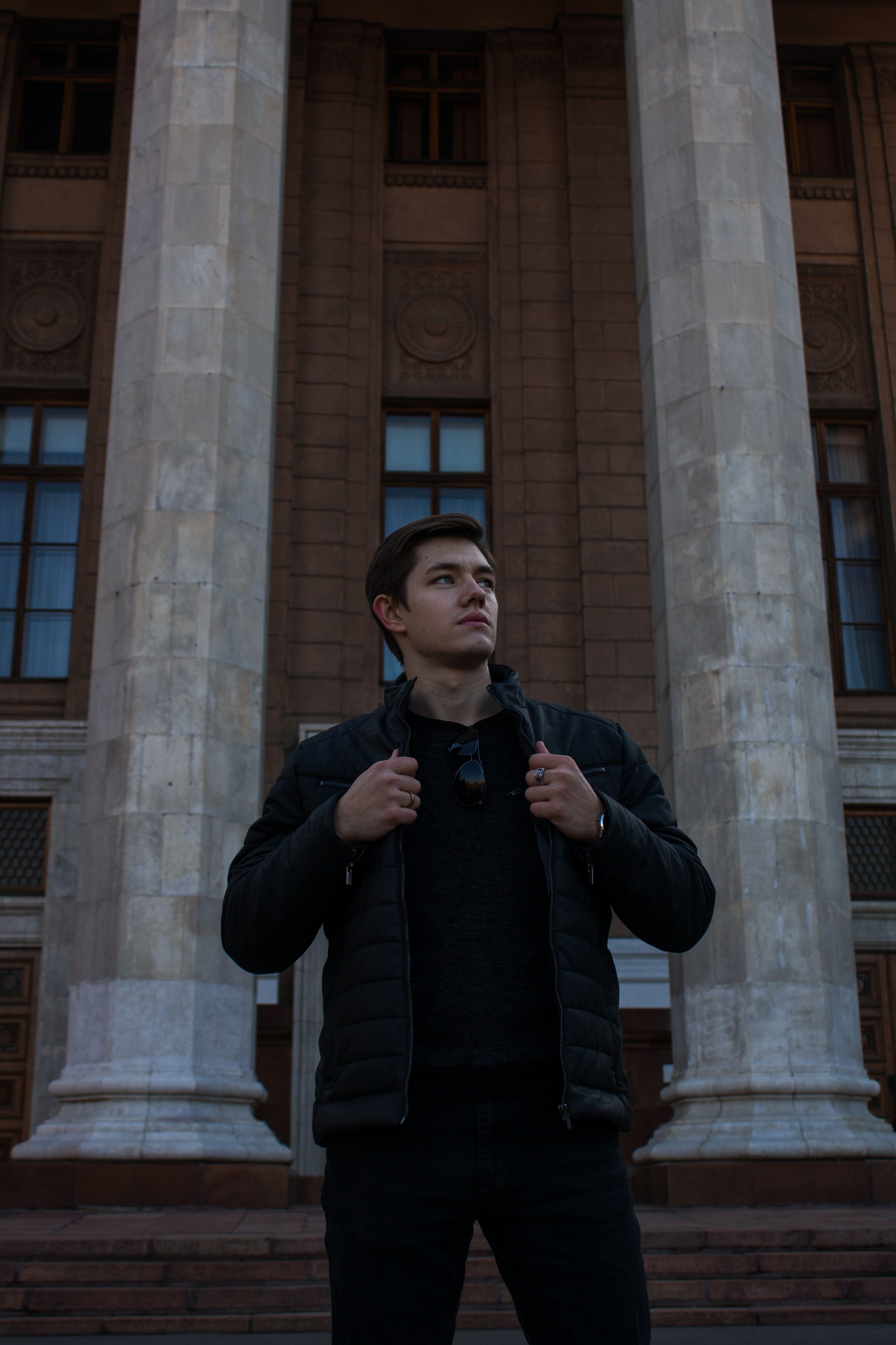 Man Standing in Front of Columns · Free Stock Photo