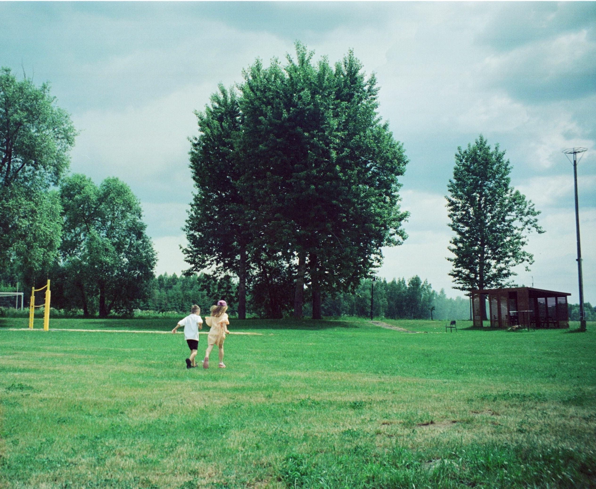 Girls Running on Green Grass Field · Free Stock Photo