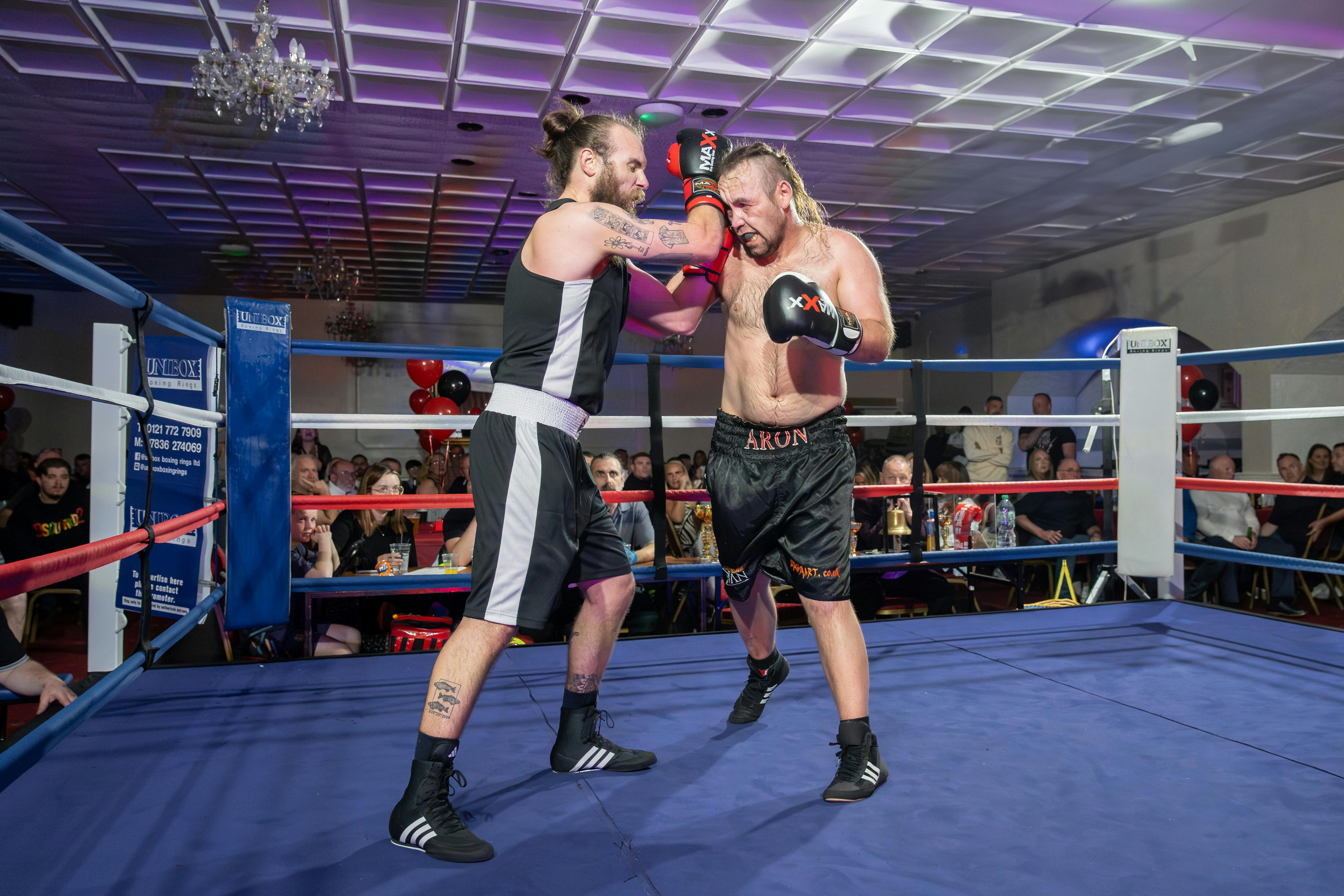 Two boxers in the ring during a boxing match · Free Stock Photo