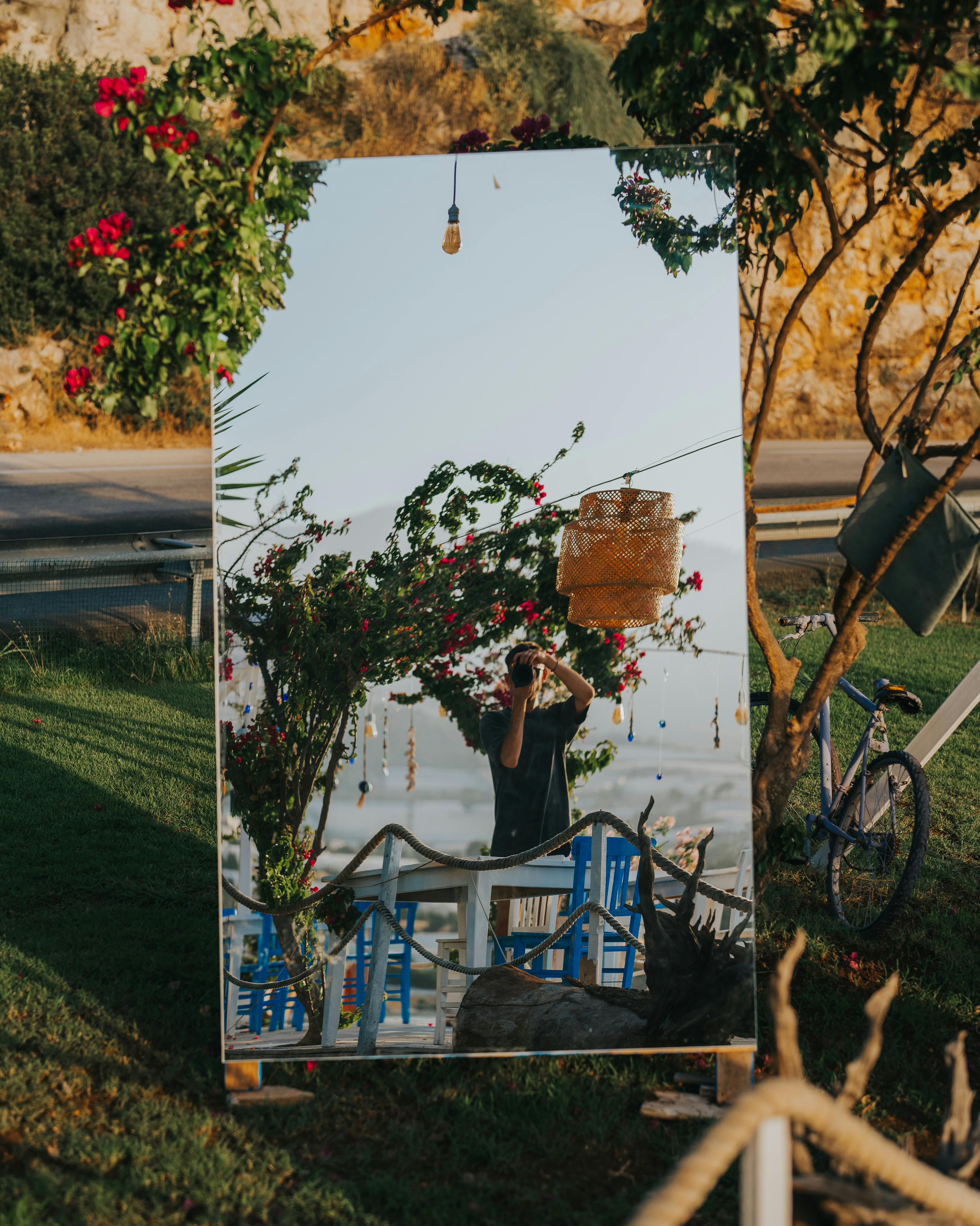 Mirror Reflection of Man Standing behind Table and Photographing · Free ...