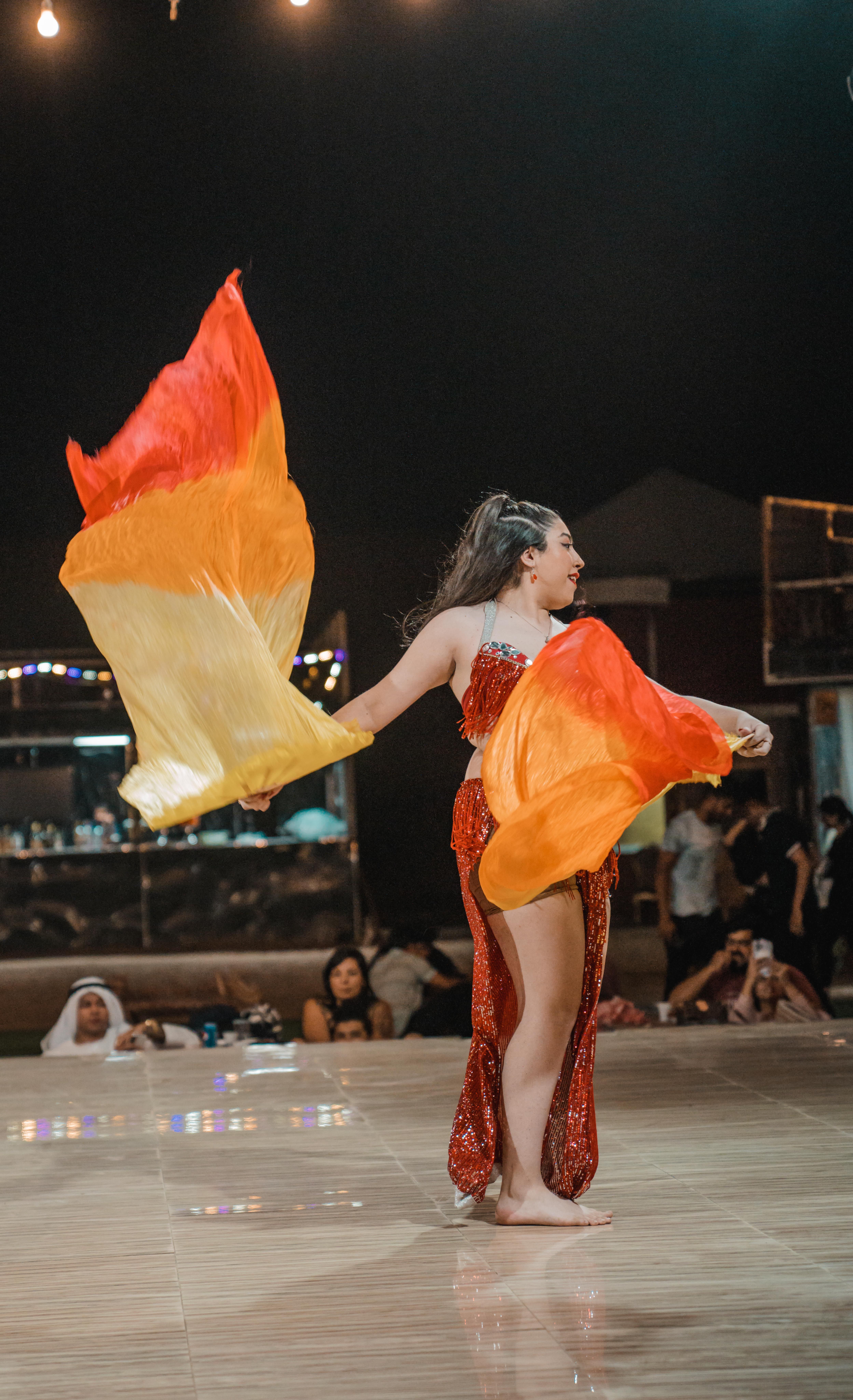 Woman with Orange Materials Performing on a Stage · Free Stock Photo