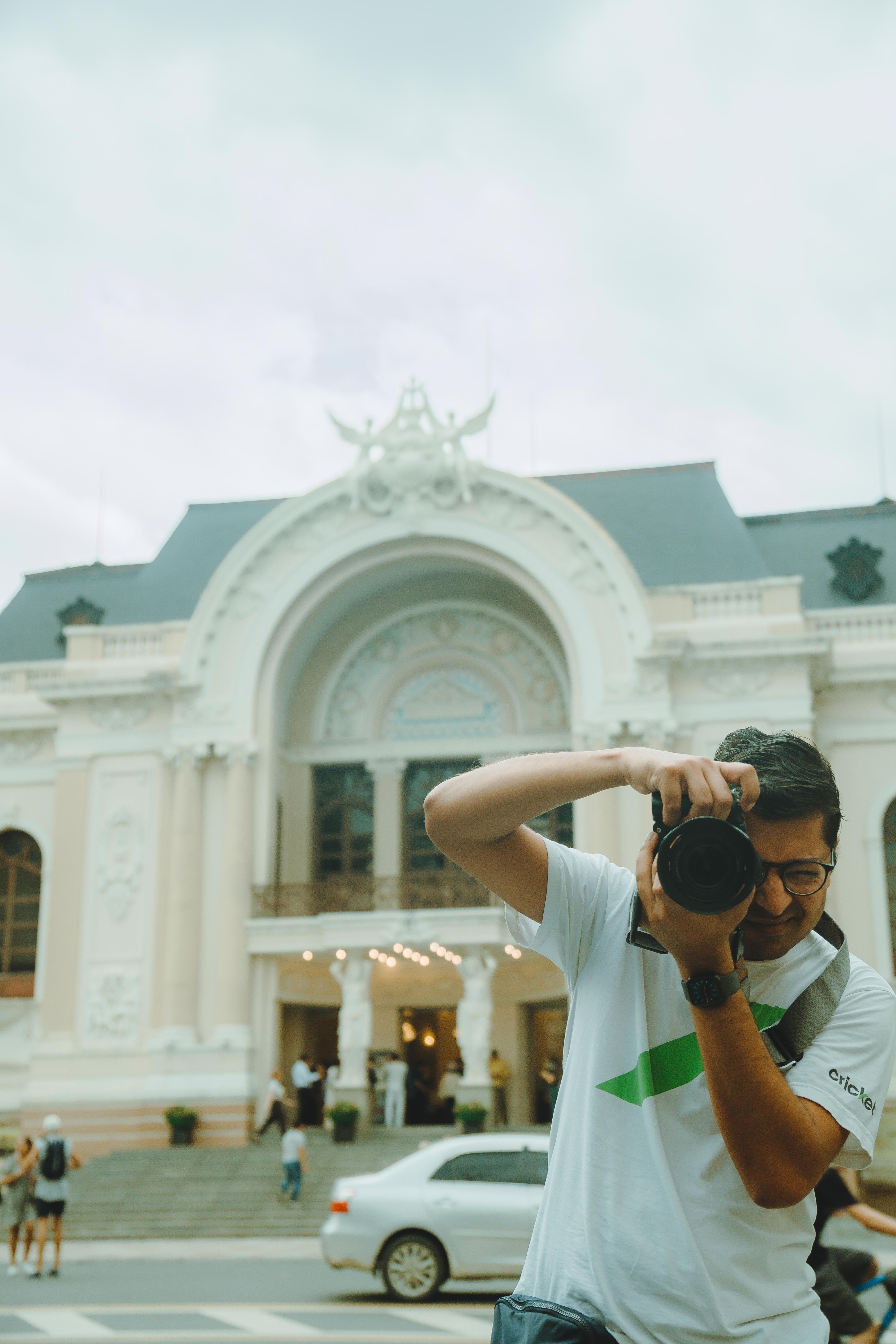 A man taking a picture of a building · Free Stock Photo