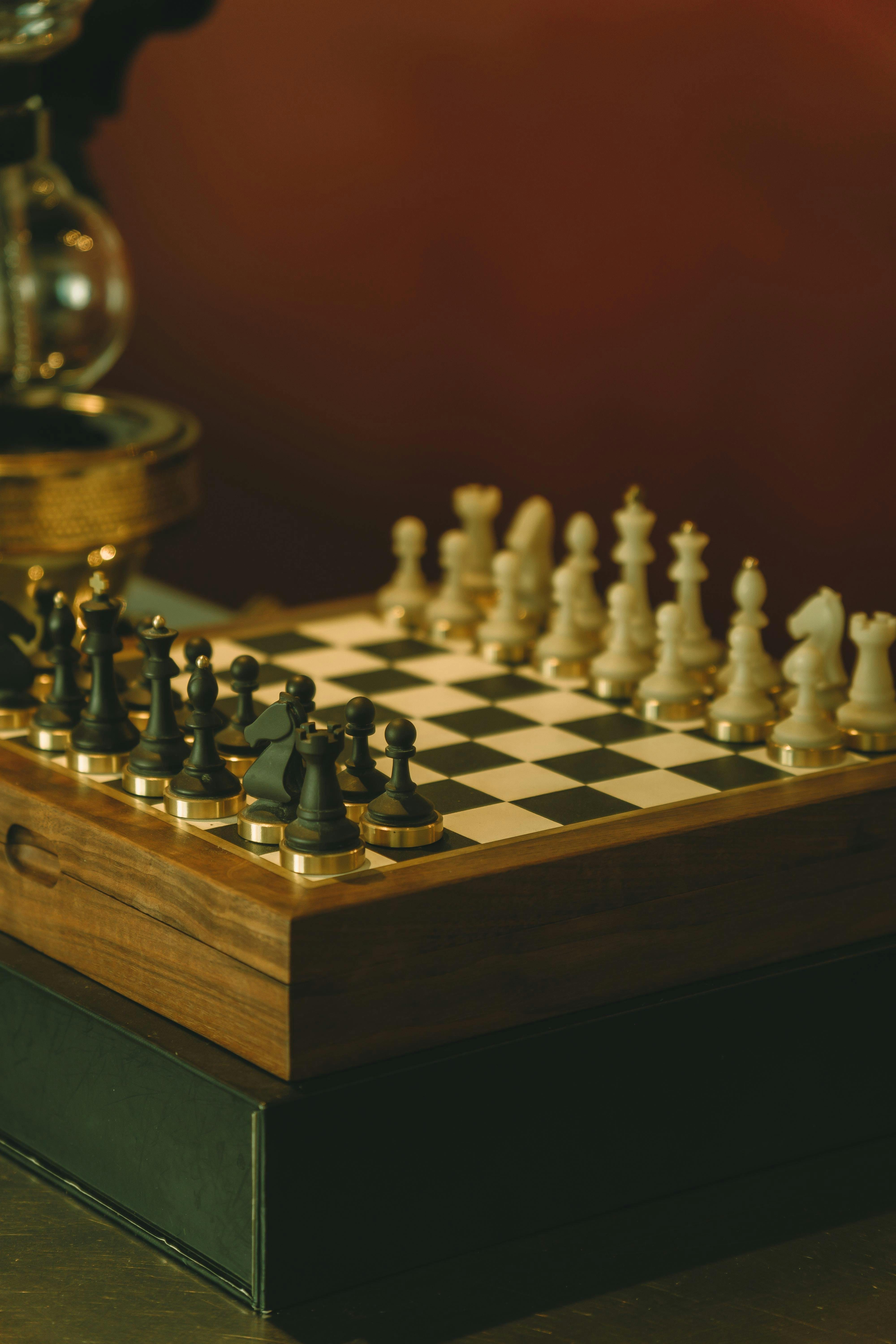 A chess set with a clock on top of it · Free Stock Photo