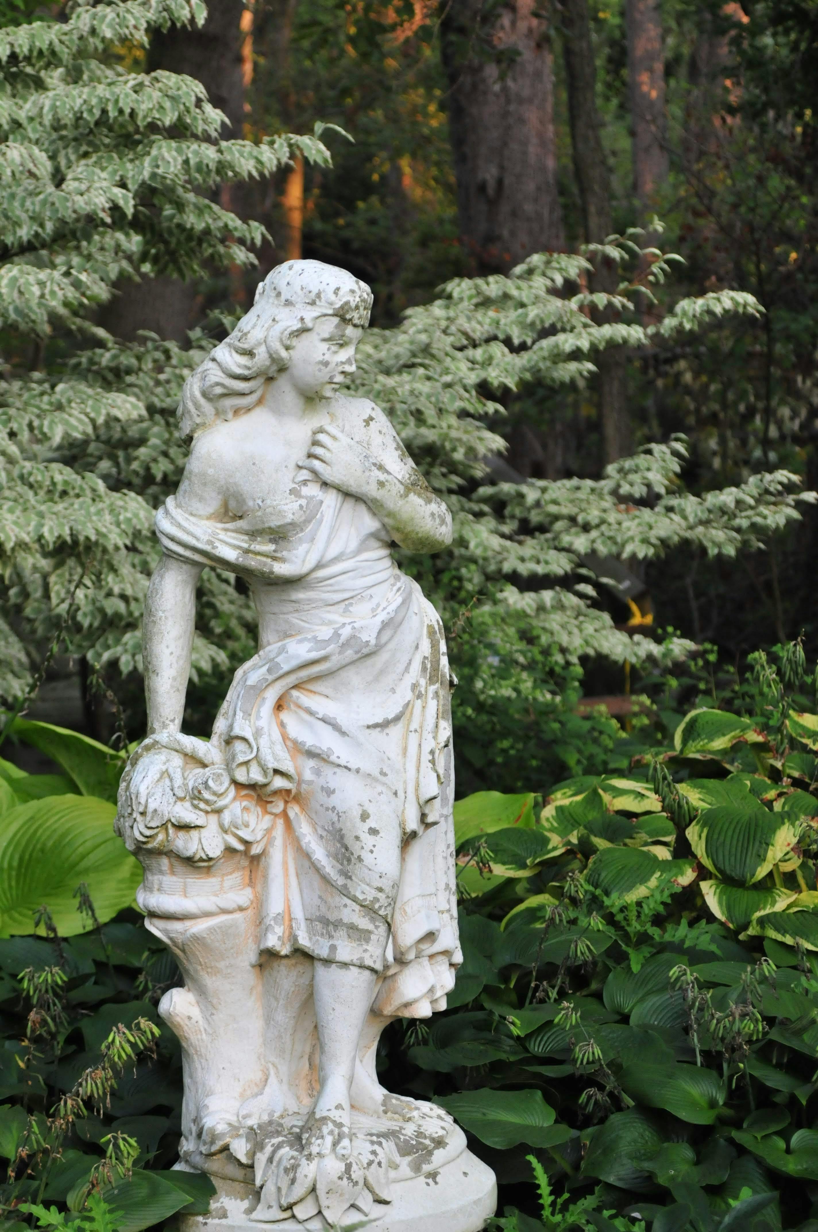Stone Woman Statue in Garden between Trees · Free Stock Photo