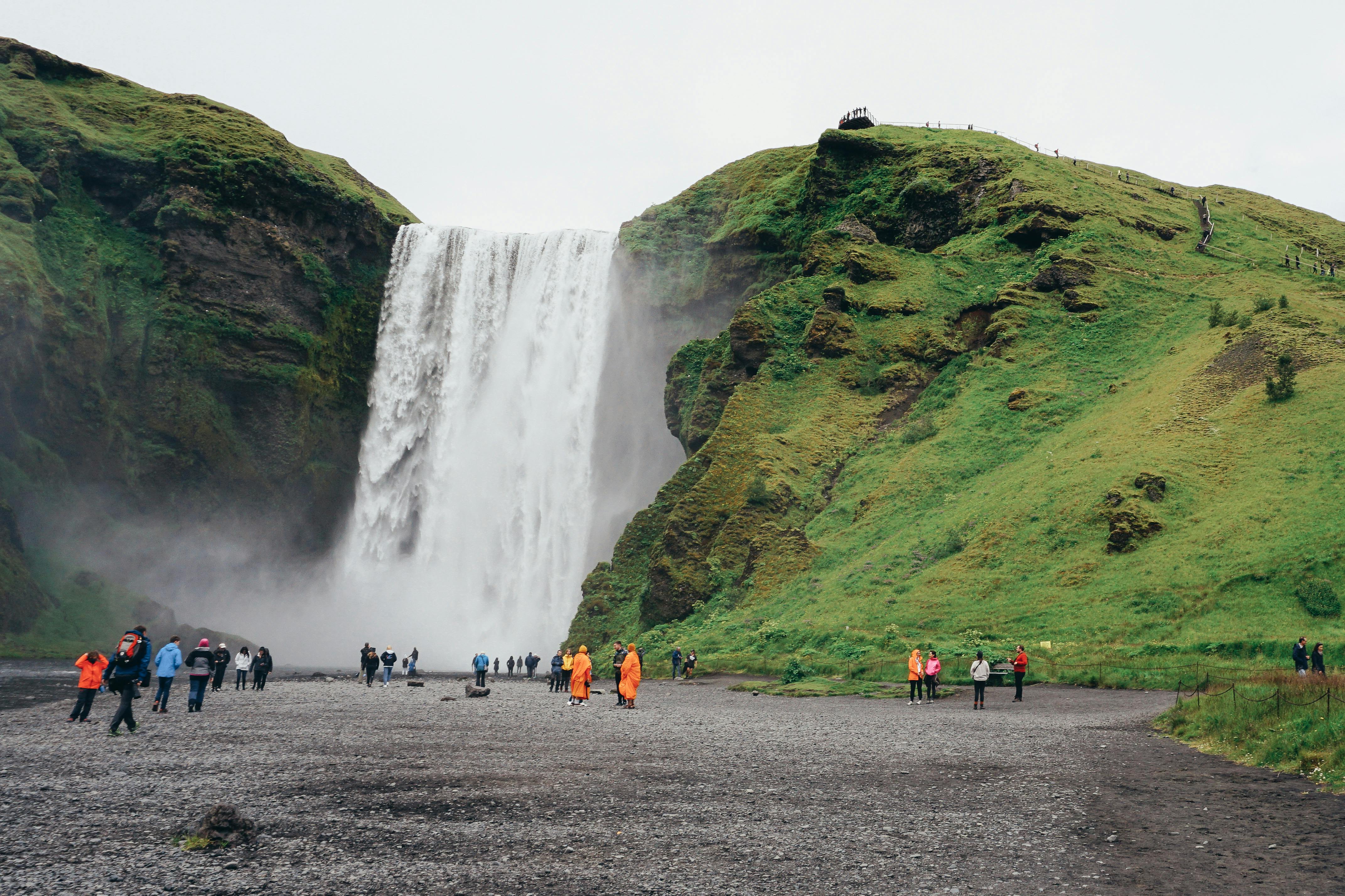 People Standing Near Waterfalls · Free Stock Photo