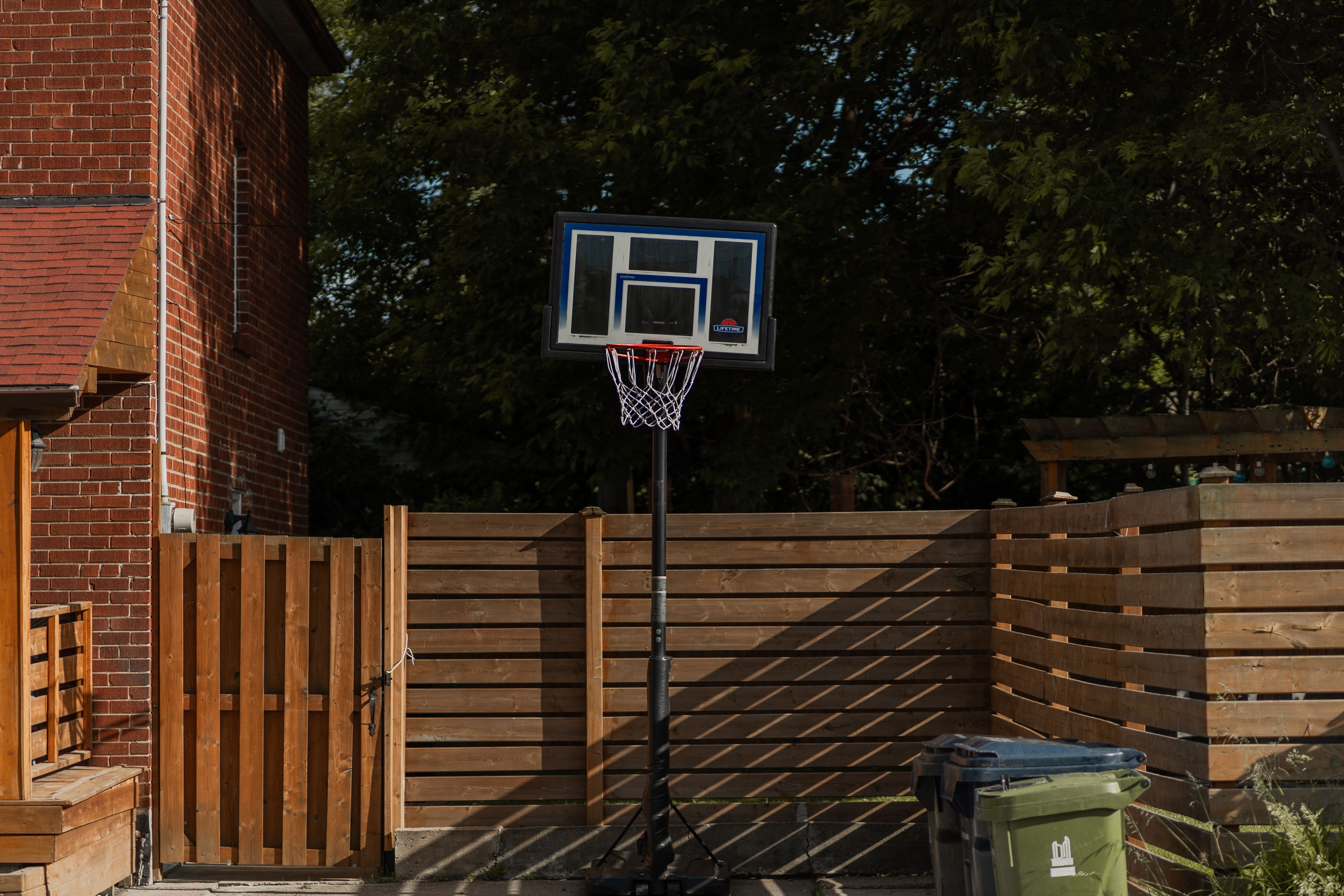 Basketball Hoop by Wooden Wall near House · Free Stock Photo